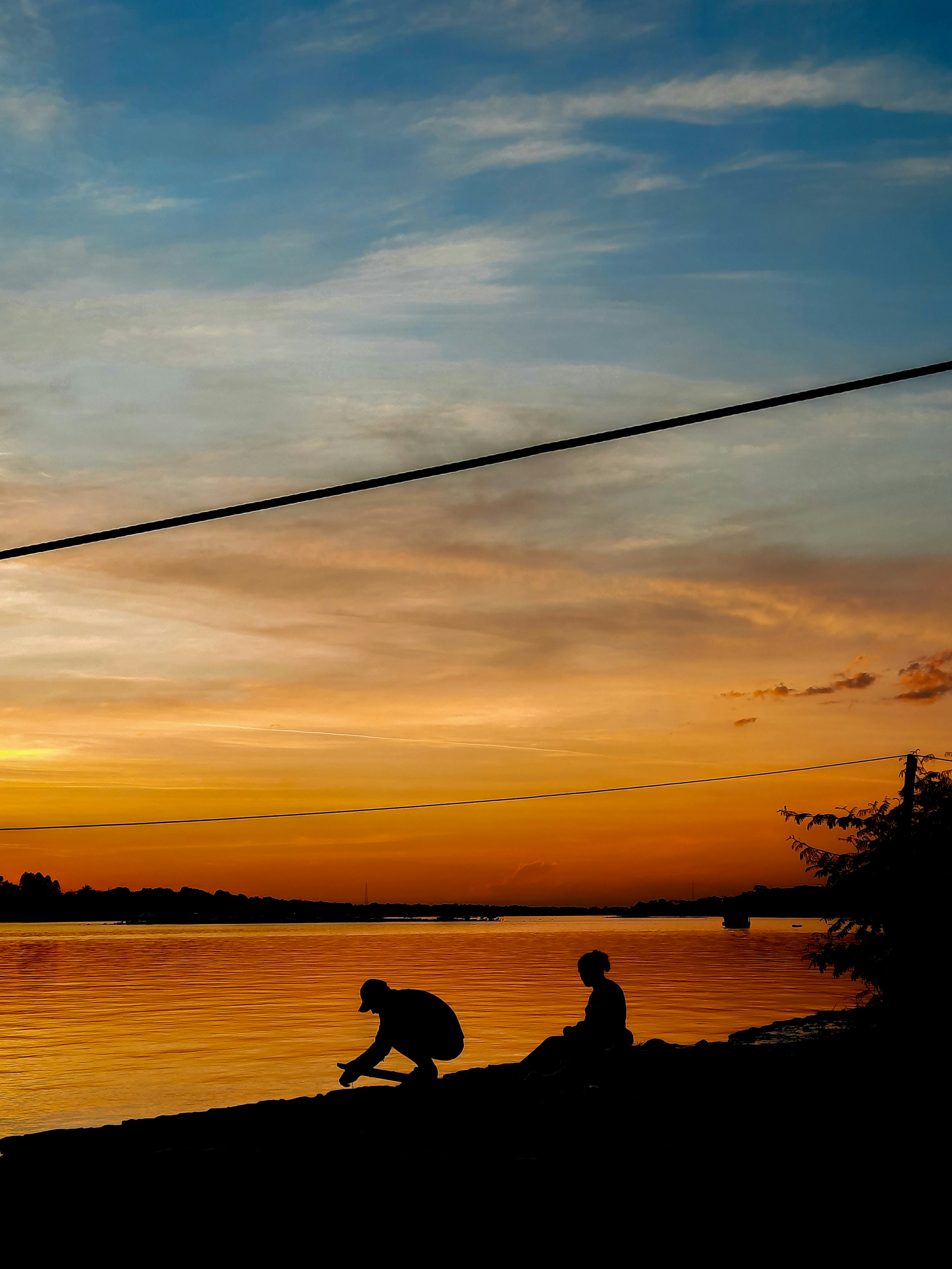 Amber Hour by the Quiet Lake: Silhouettes at Dusk