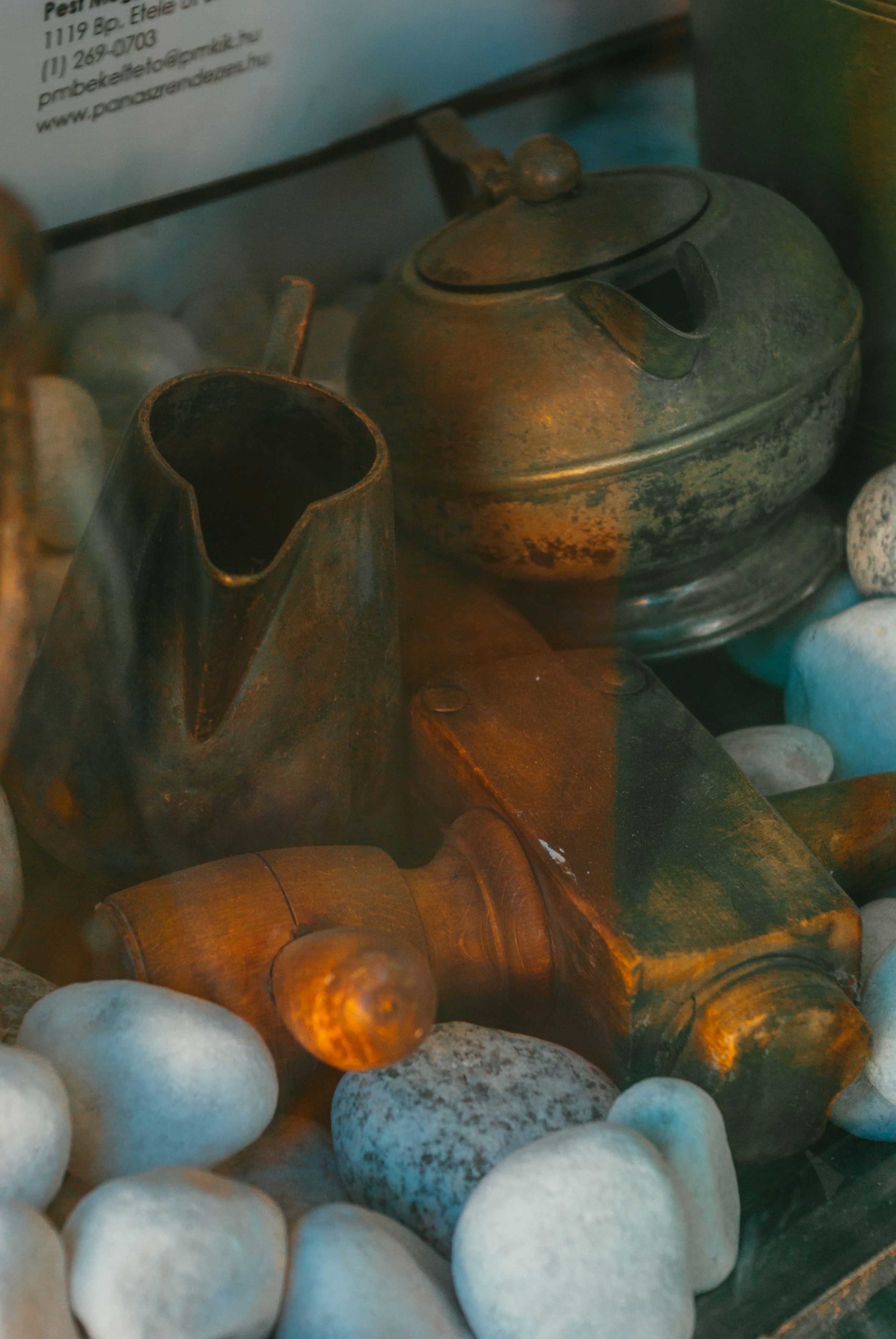A tea pot, kettle, and rocks in a display case photo – Free Brown Image ...