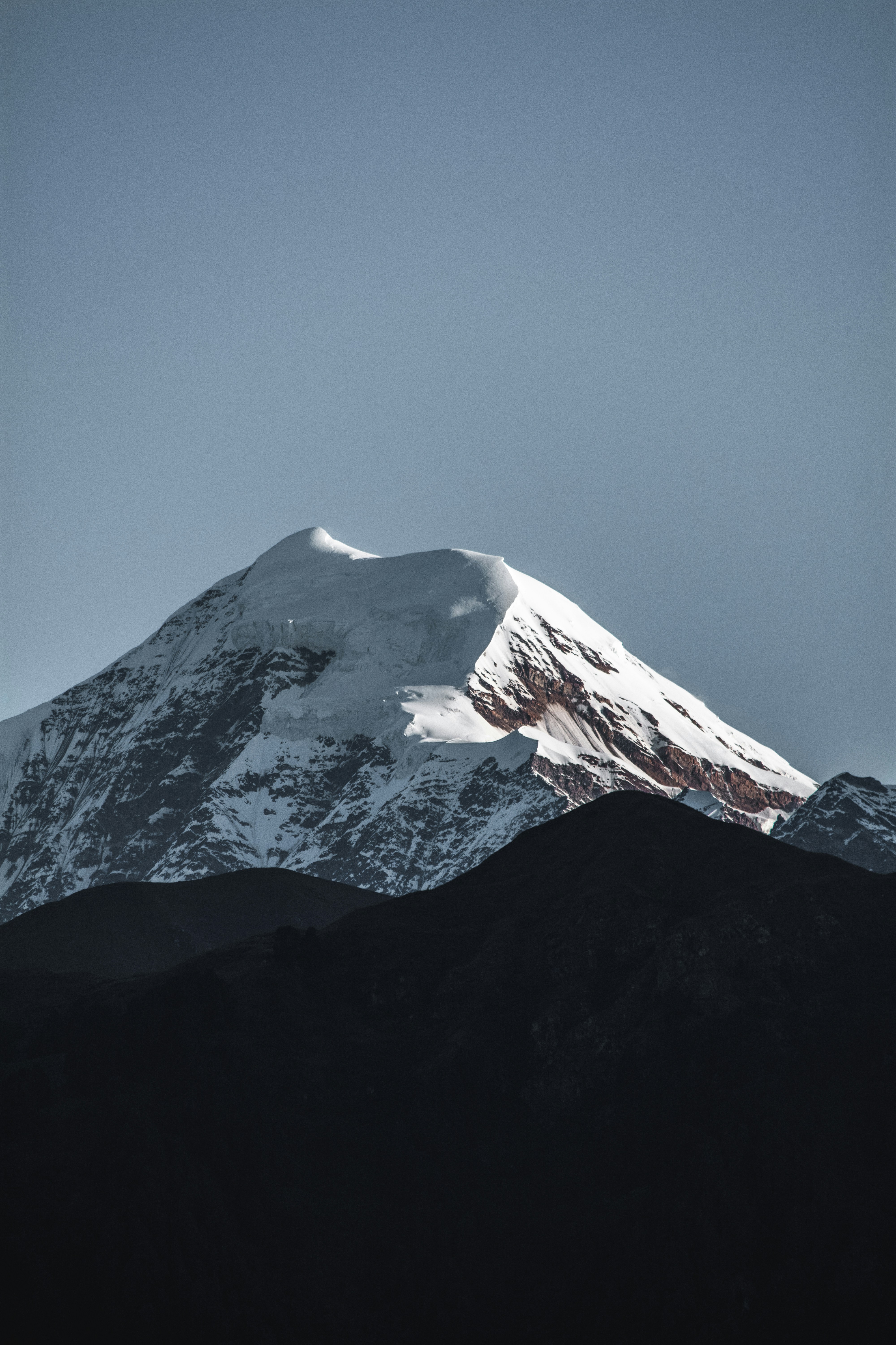 Snow-Crowned Peak Piercing a Clear Sky