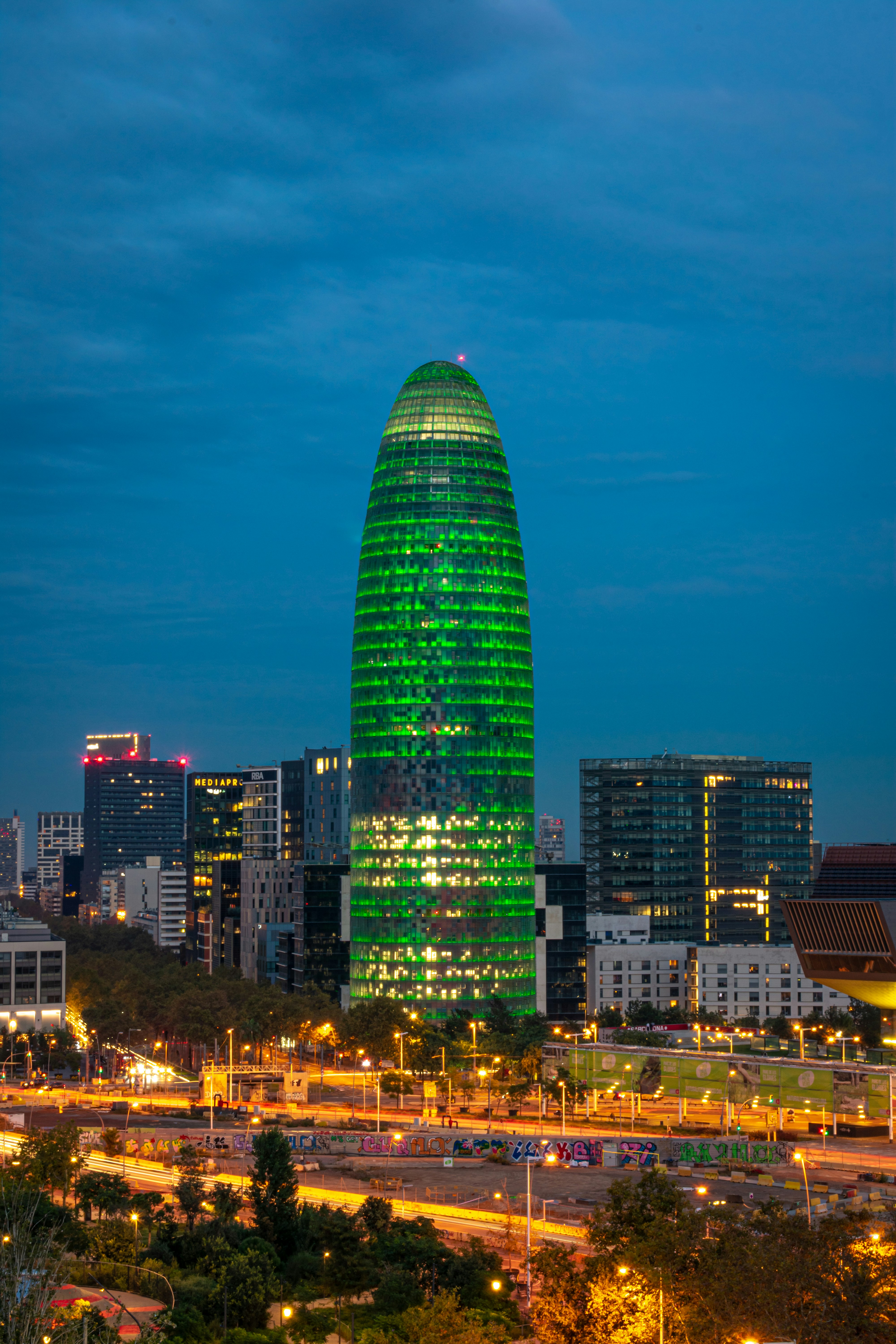Emerald Spire Rising Over Blue Hour Cityscape