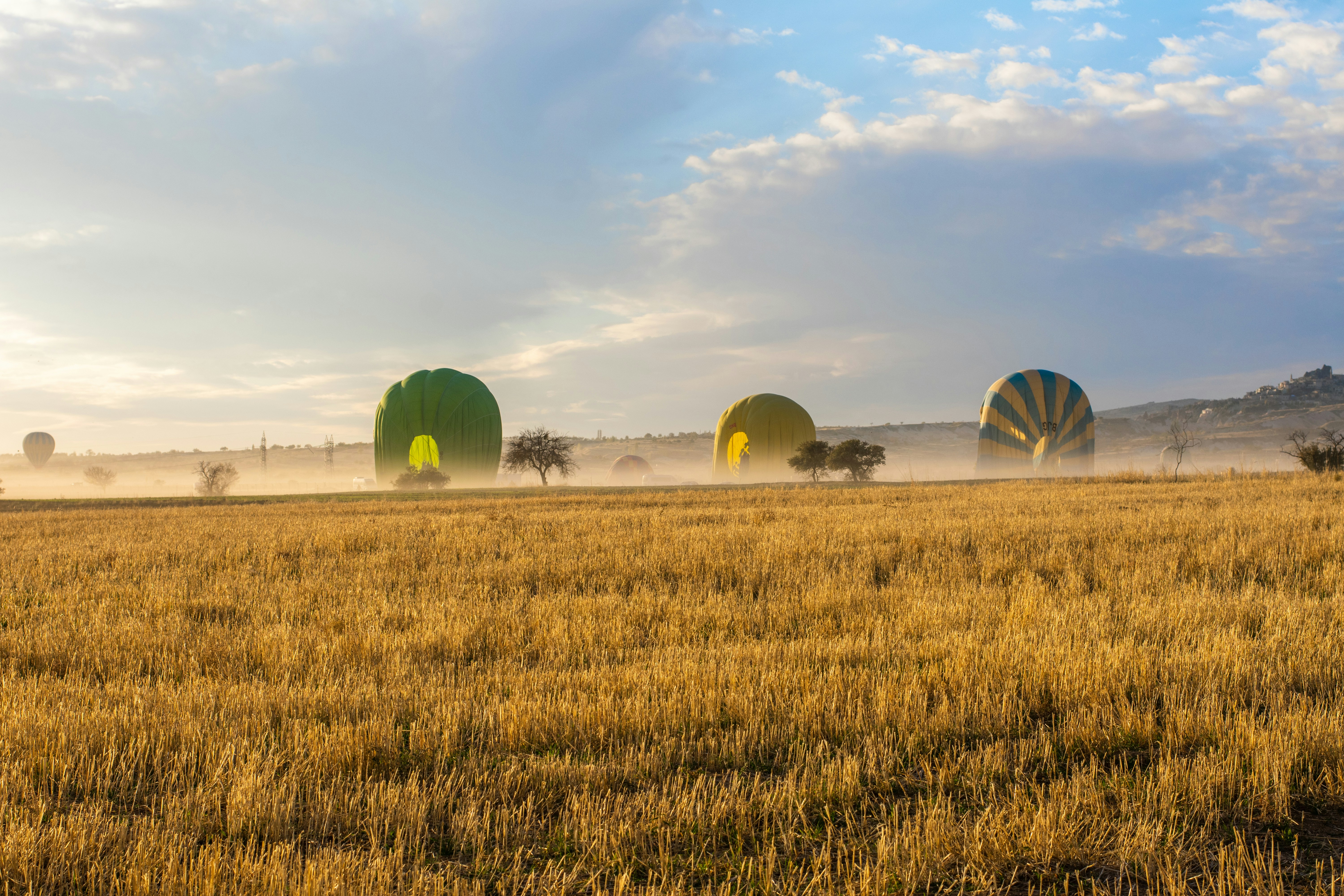 Three hot air balloons in the middle of a field photo – Free Kapadokya ...