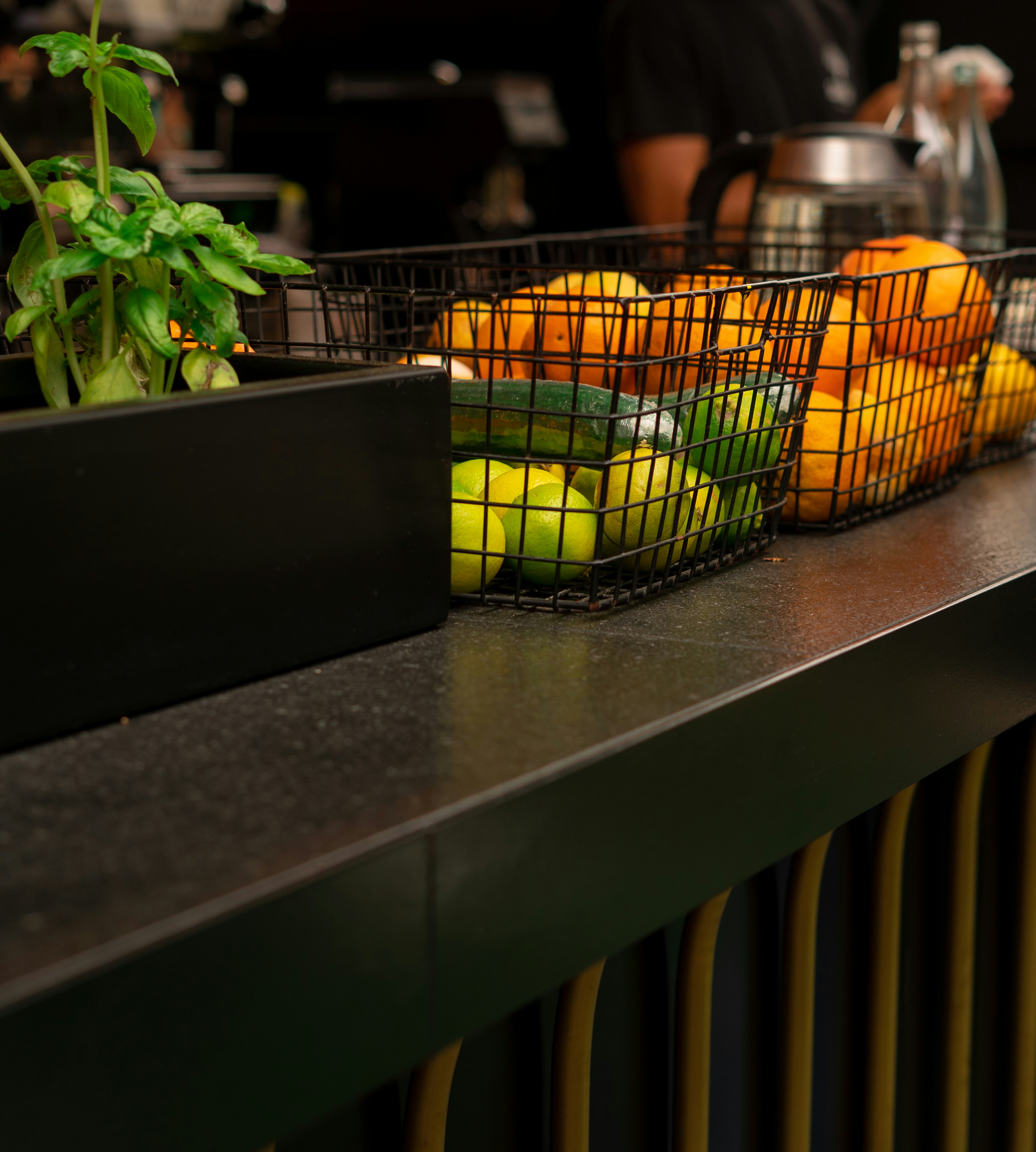 Citrus Grid: Wire Baskets on a Quiet Cafe Counter