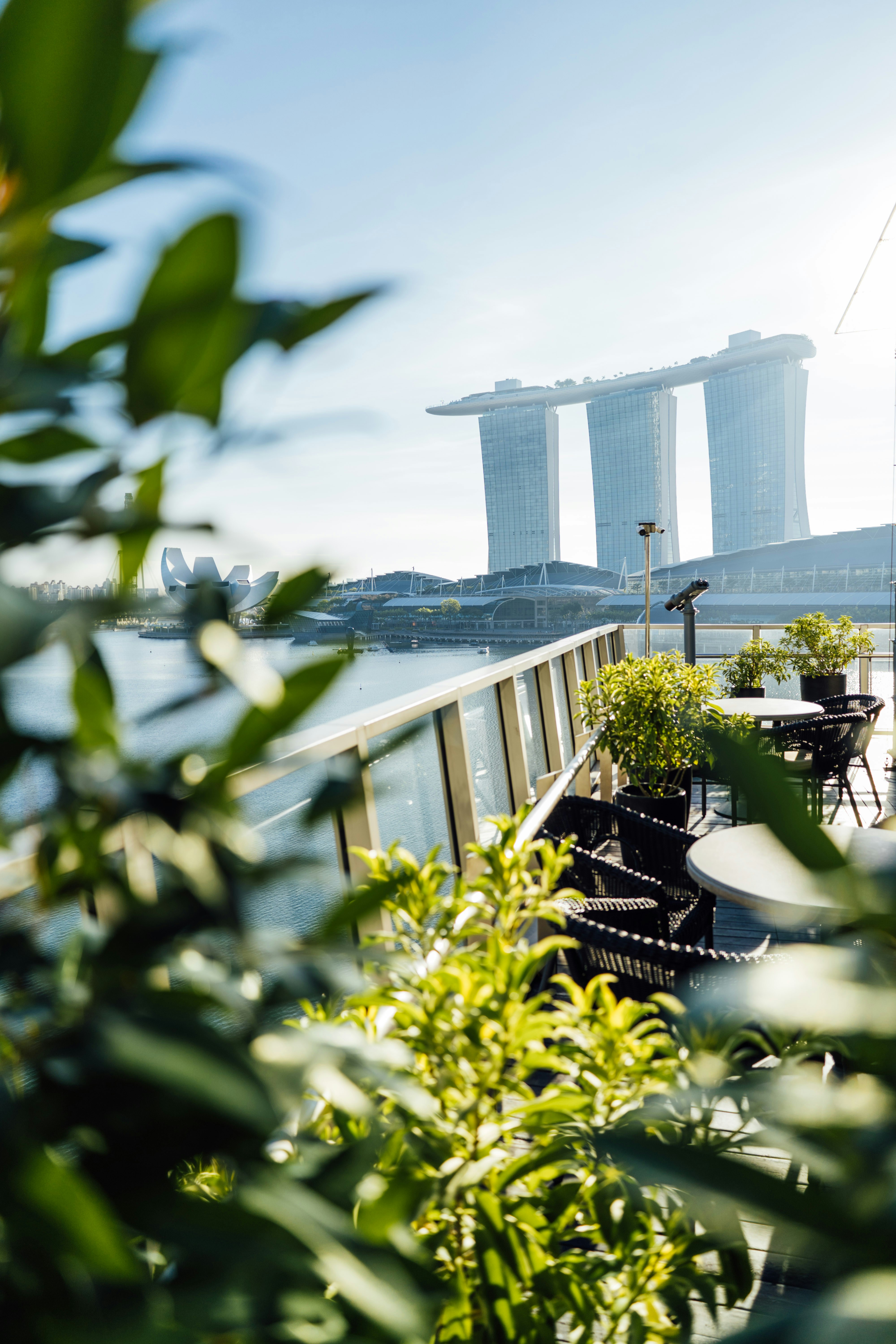 A balcony overlooking a body of water with buildings in the background ...