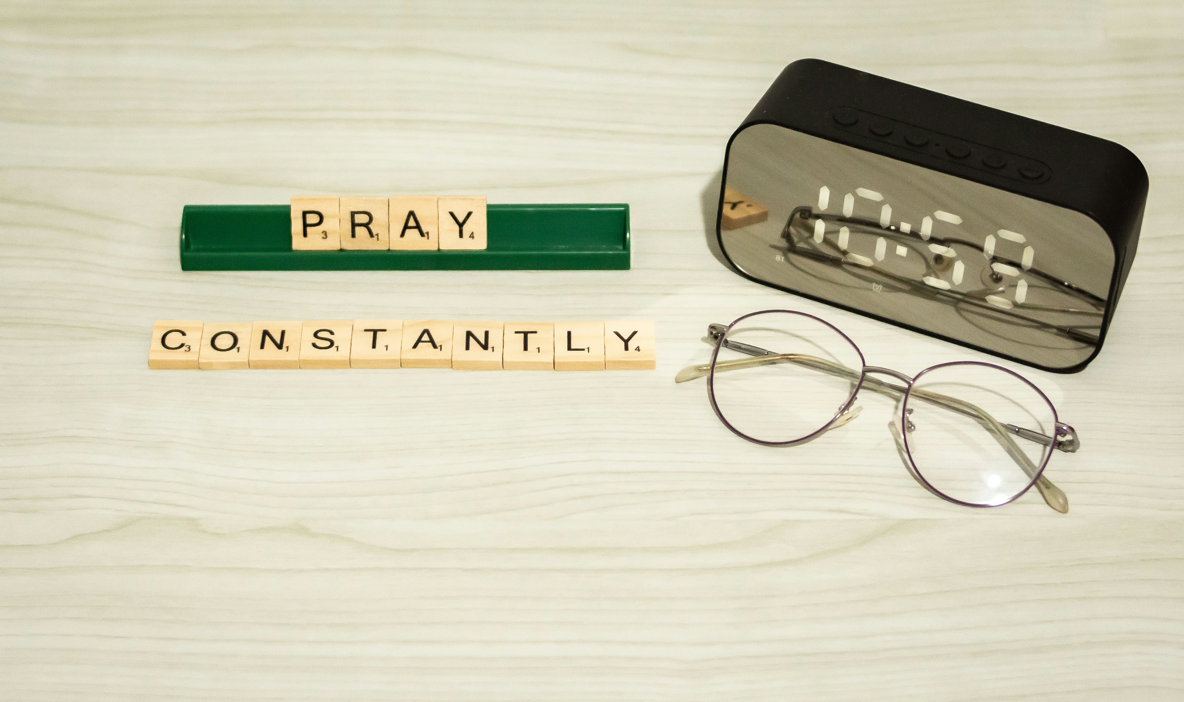 A pair of glasses sitting next to some scrabble letters photo – Free ...