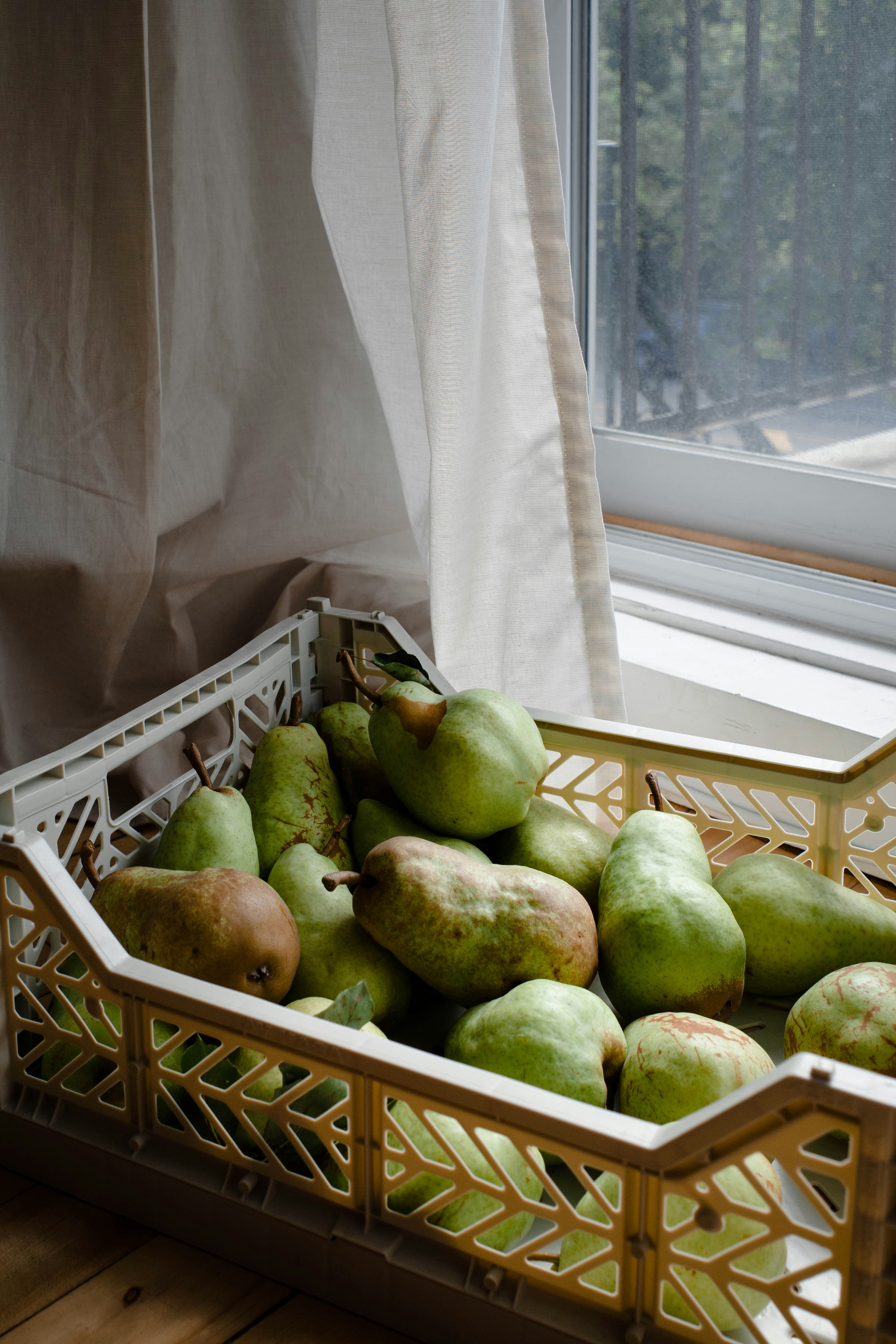 a basket full of pears sitting on a table