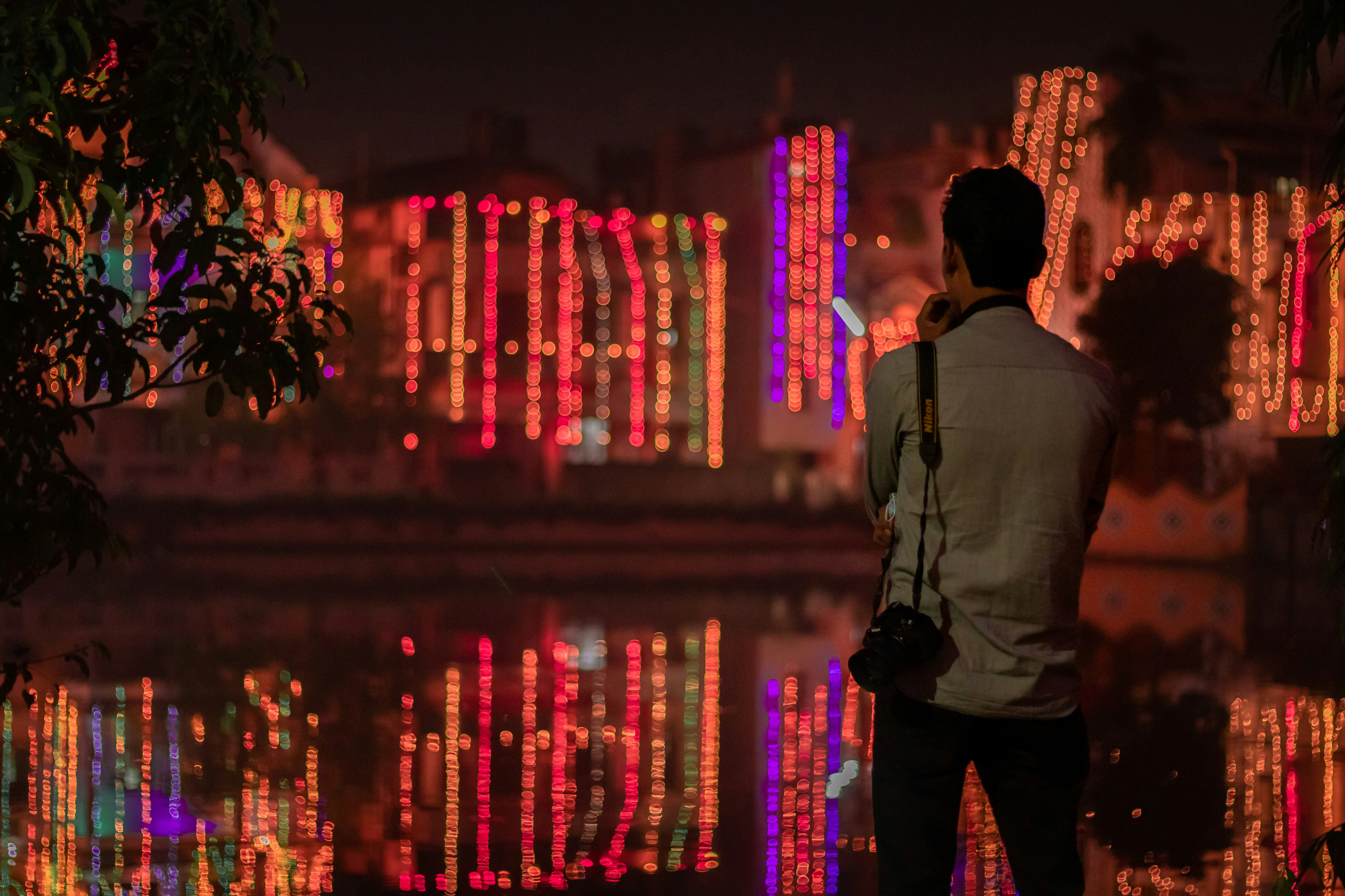 Evening Confidant: A Photographer Captures Neon Reflections by the Waterfront