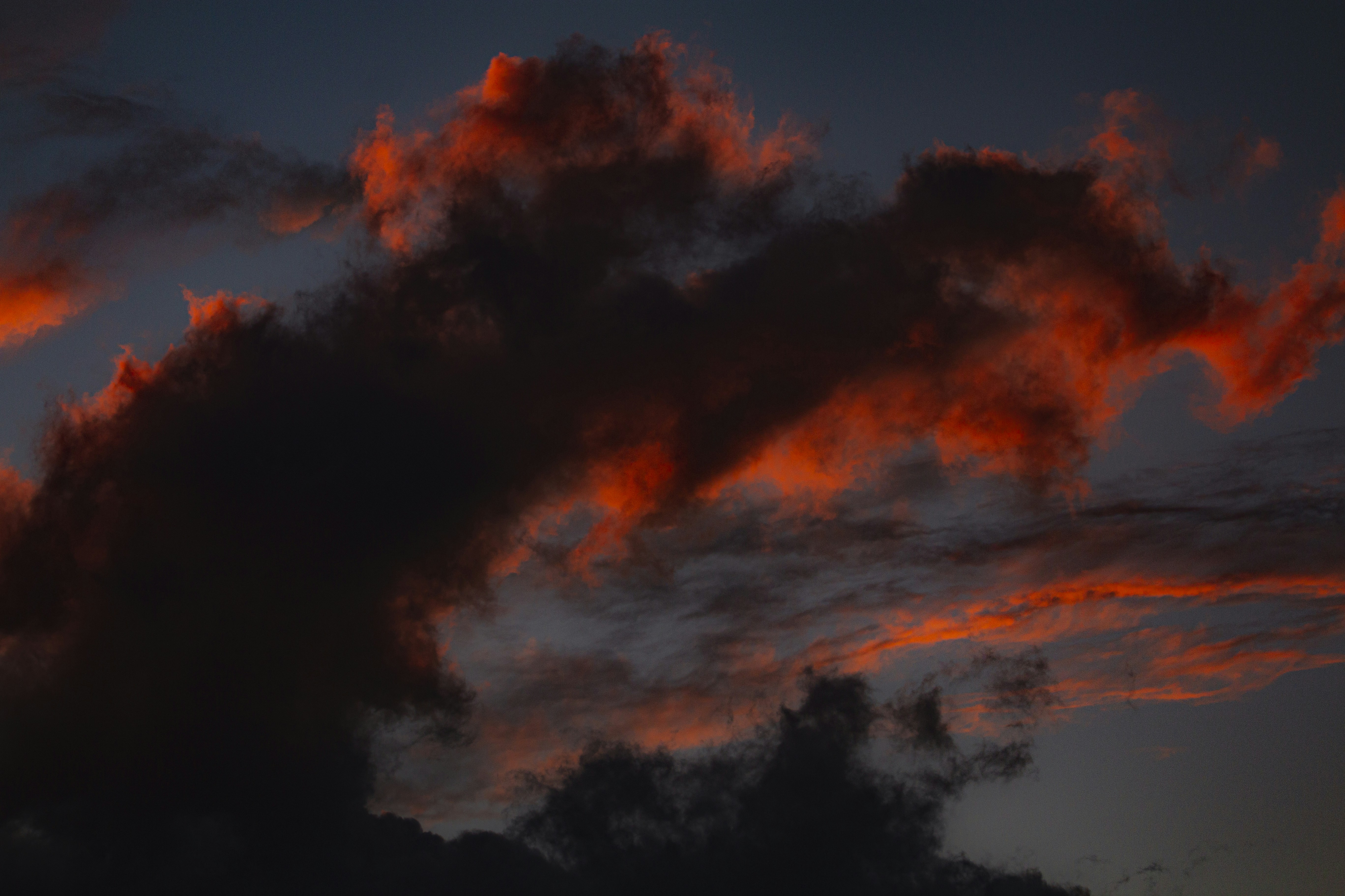 Vibrant clouds illuminated by the fading light of sunset, creating a dramatic interplay of colors in the evening sky.