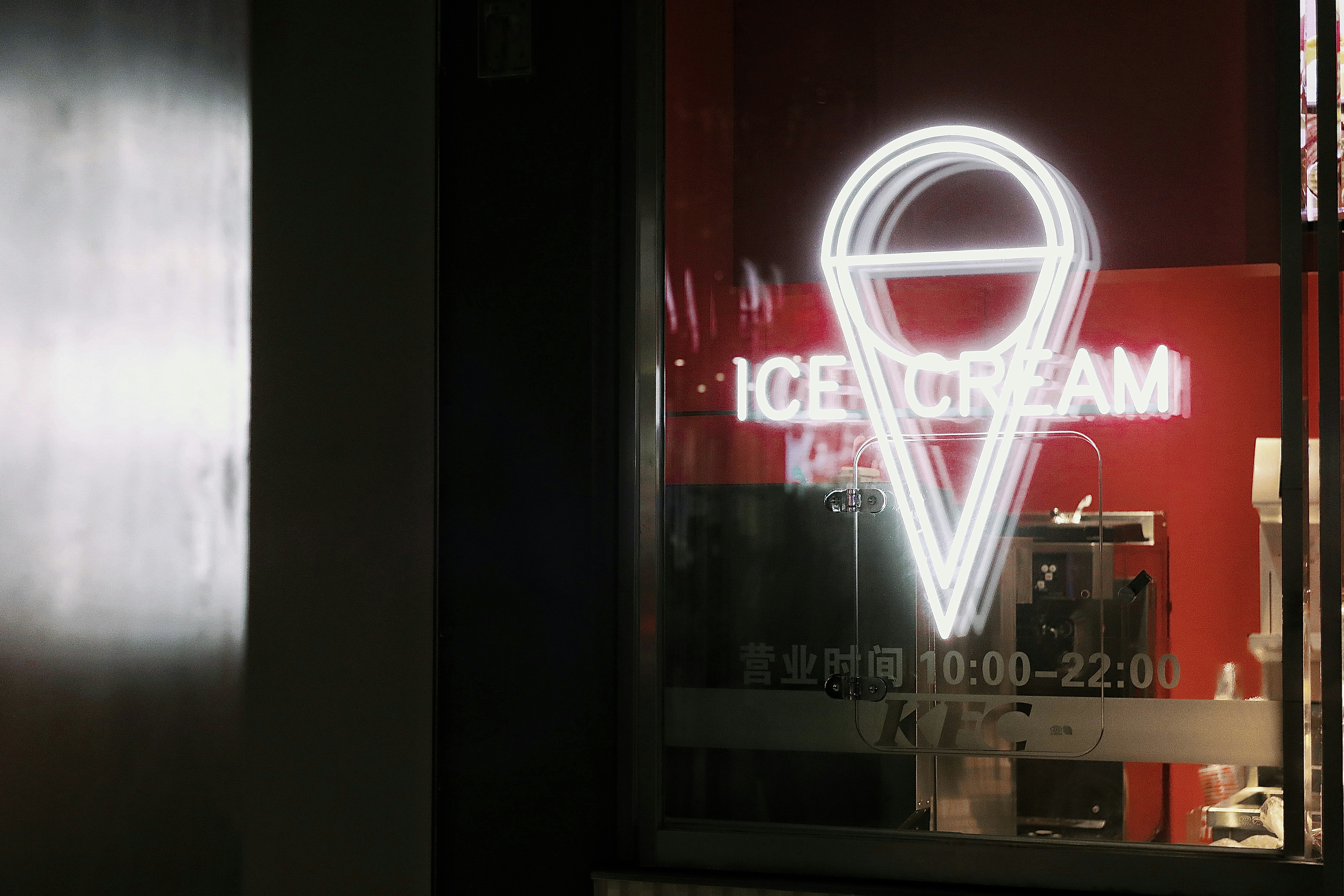Neon Ice-Cream Emblem in a Nighttime Window