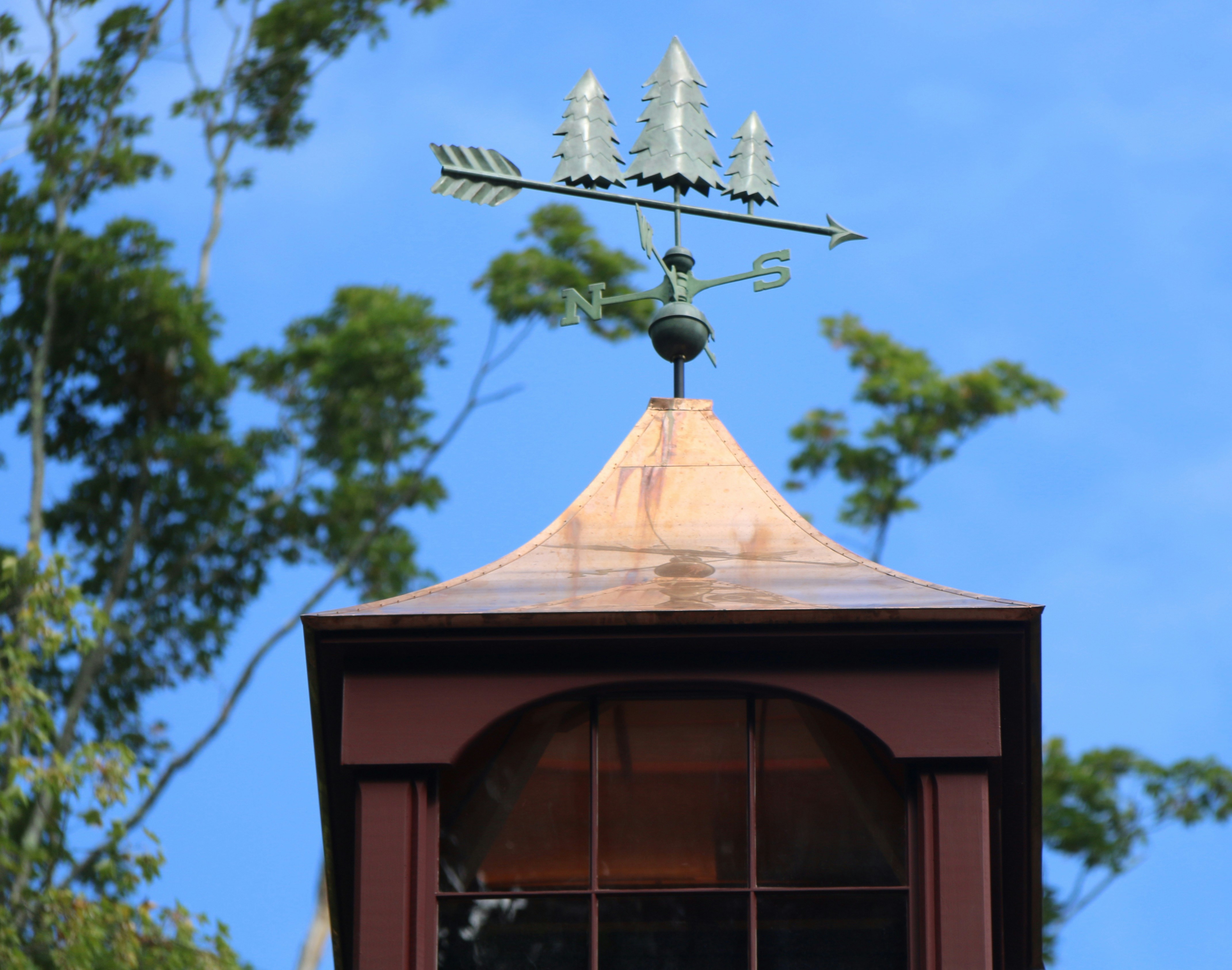 A weather vane on top of a building photo – Free Weather vane Image on ...