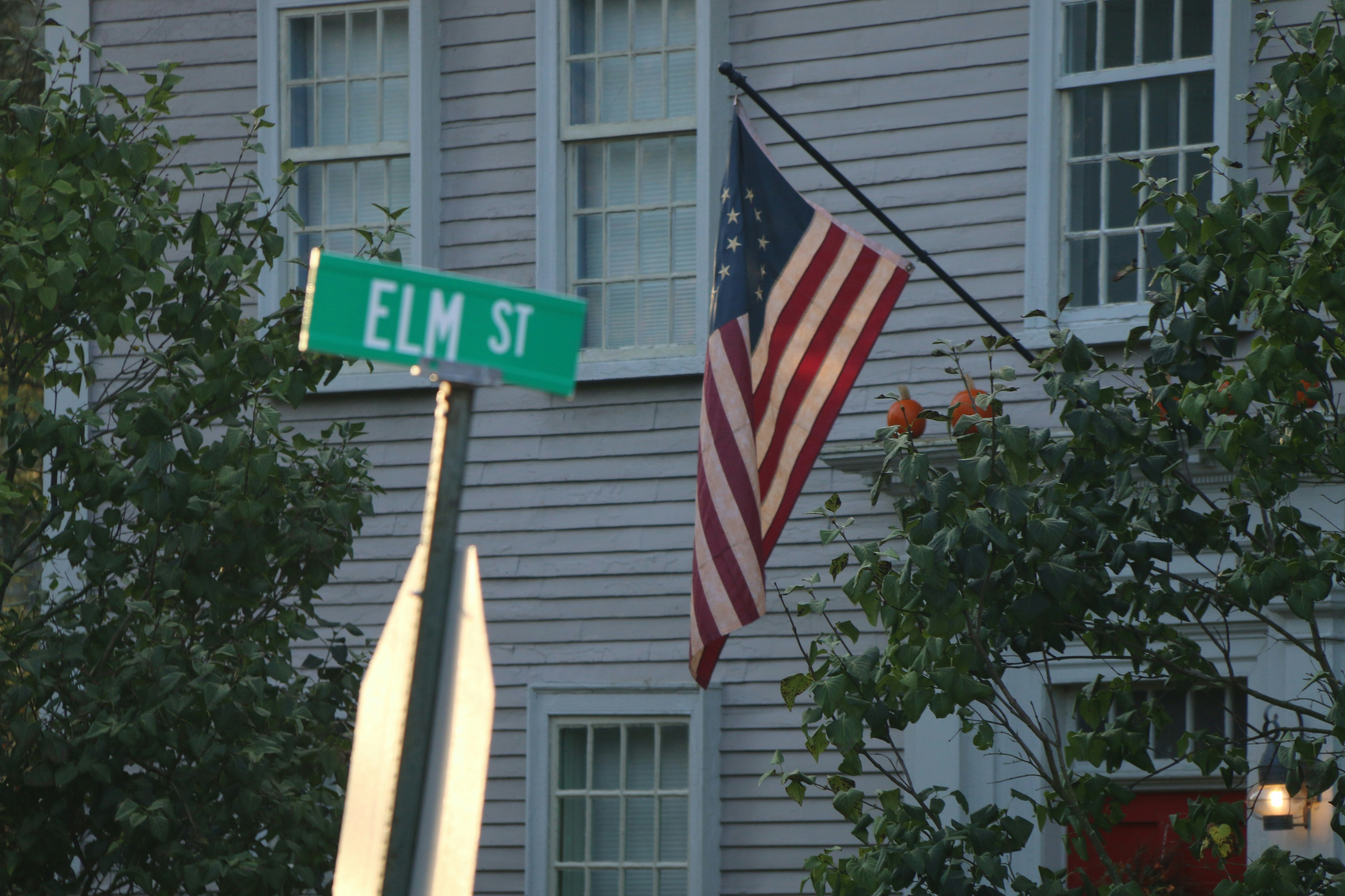 A green street sign sitting next to a tall building photo – Free Groton ...