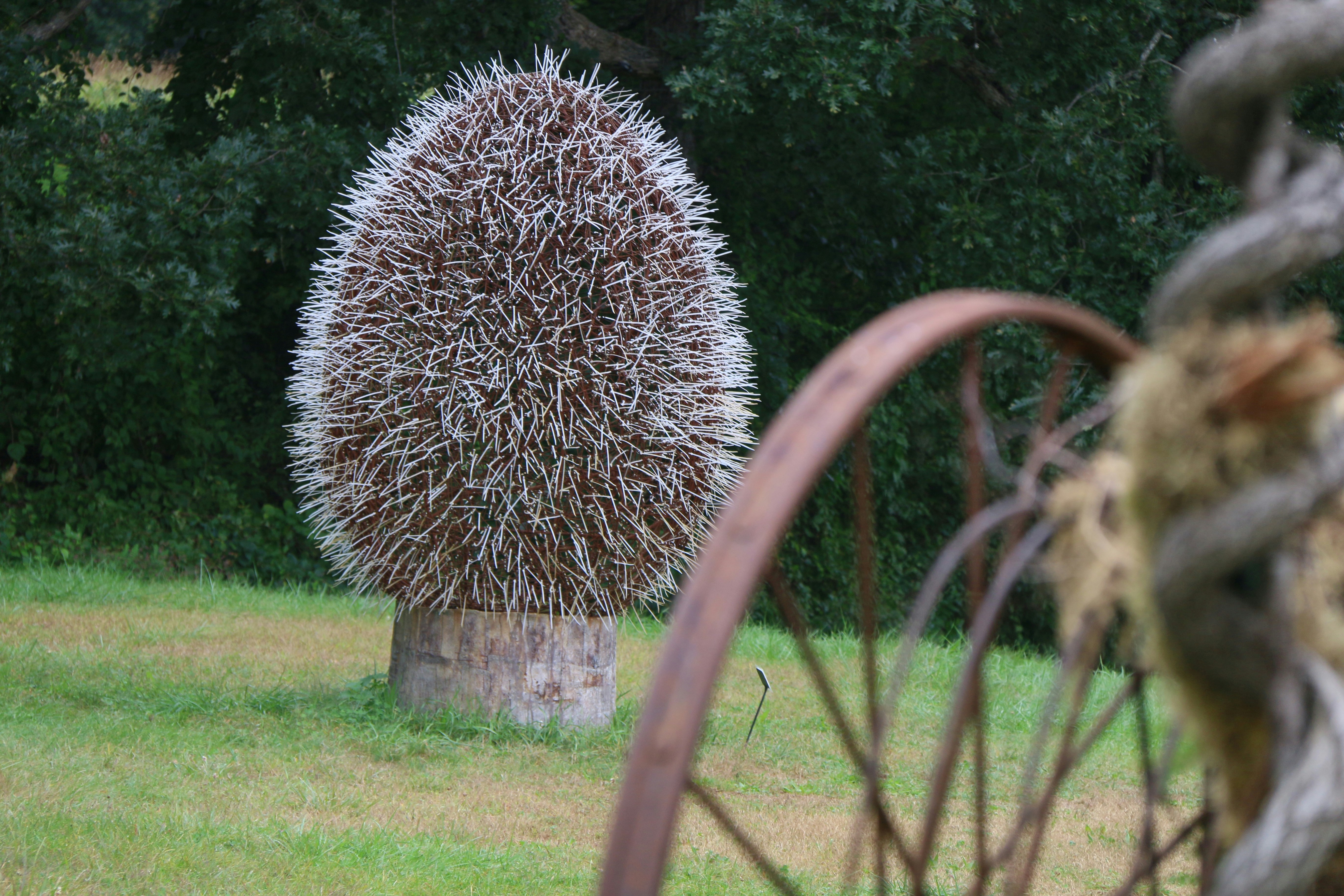 The Odd Sculpted Sentinel: A Spiky Monolith in a Field