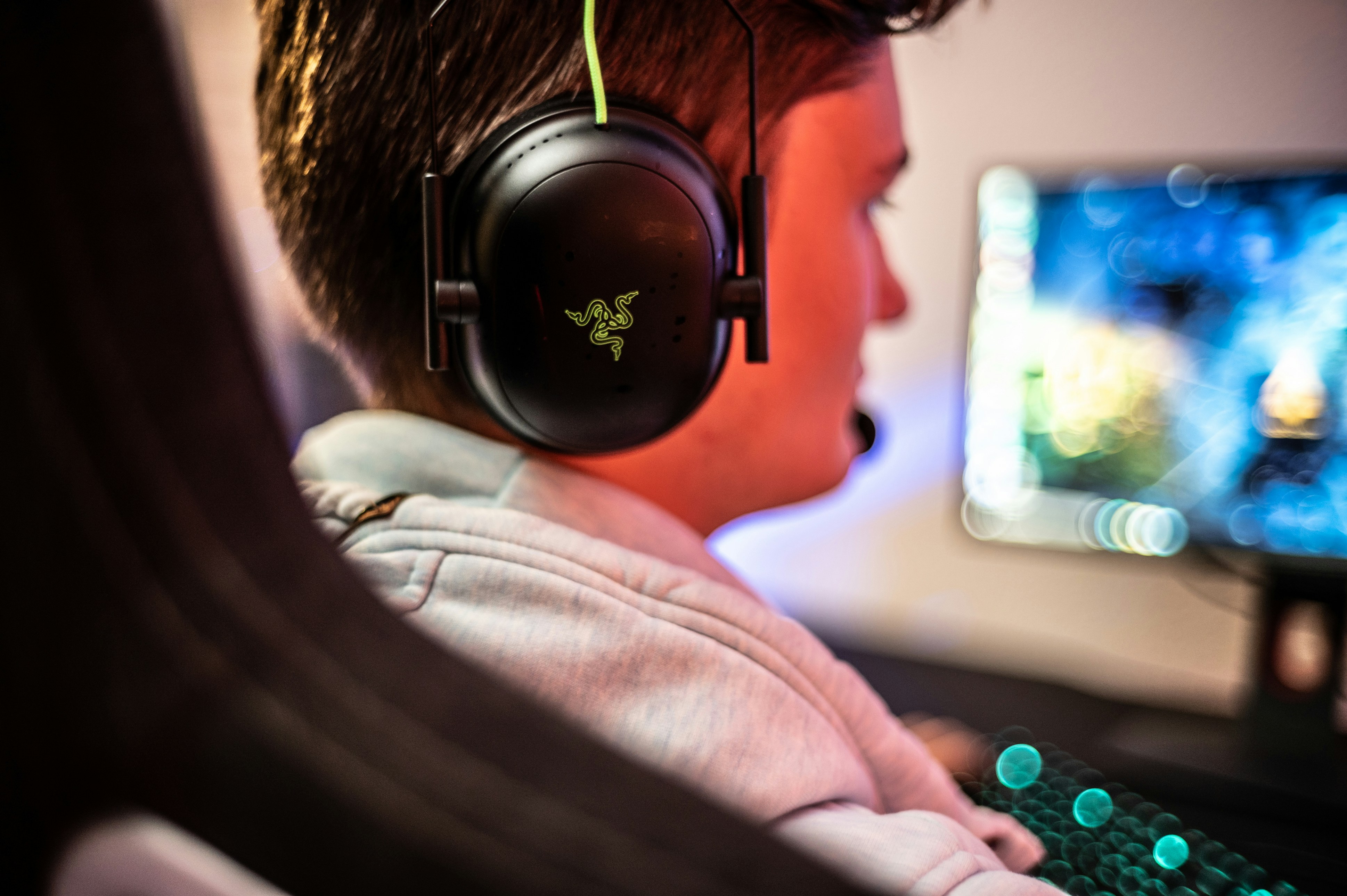 Headset in Focus: Neon Glow and Quiet Concentration at the Desk