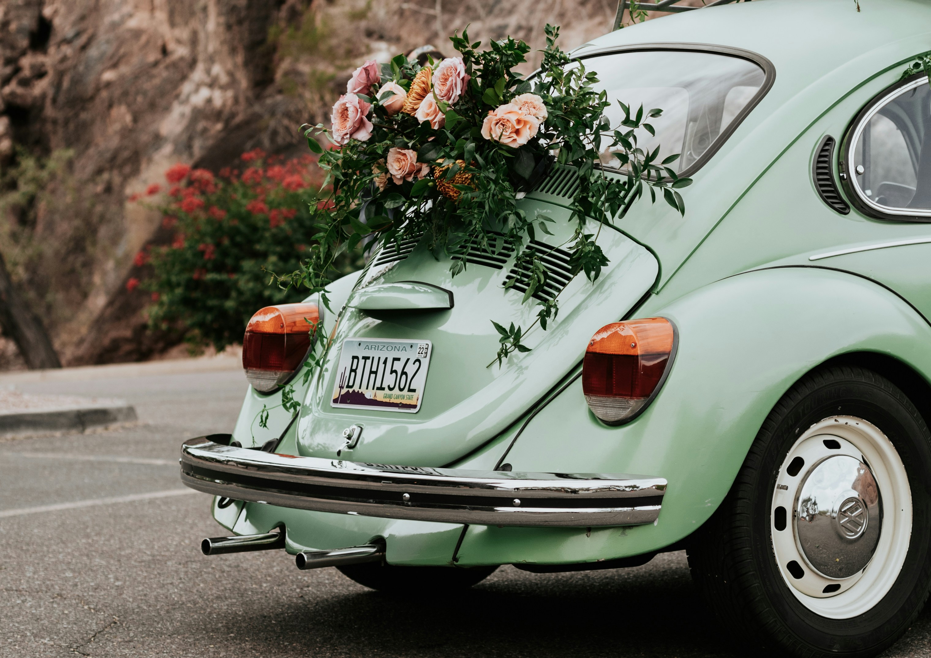 Bouquet on Mint Beetle: A Vintage Wedding Car Adorned with Peach Flowers