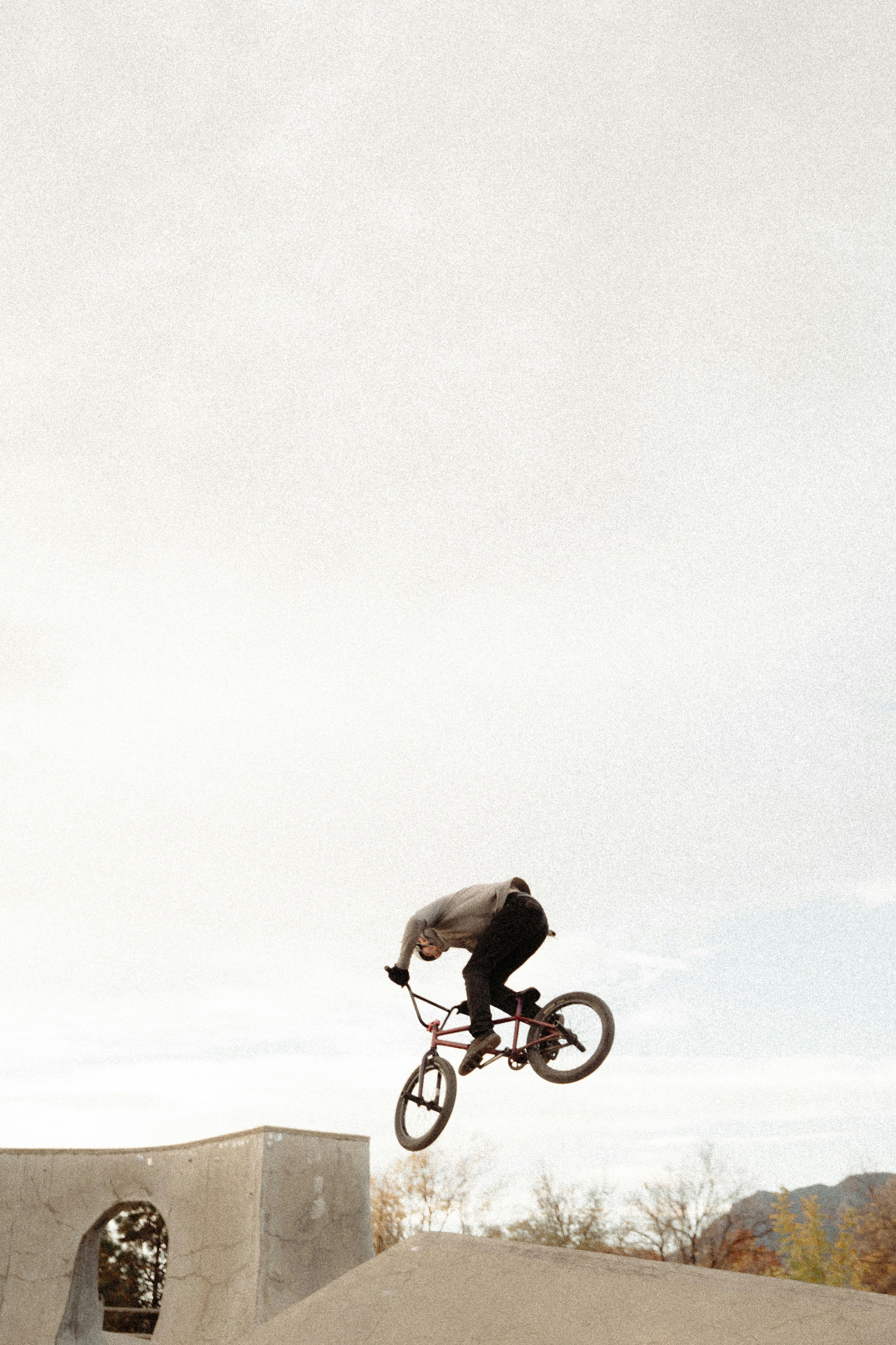 A man riding a bike up the side of a ramp photo – Free Mountains Image ...