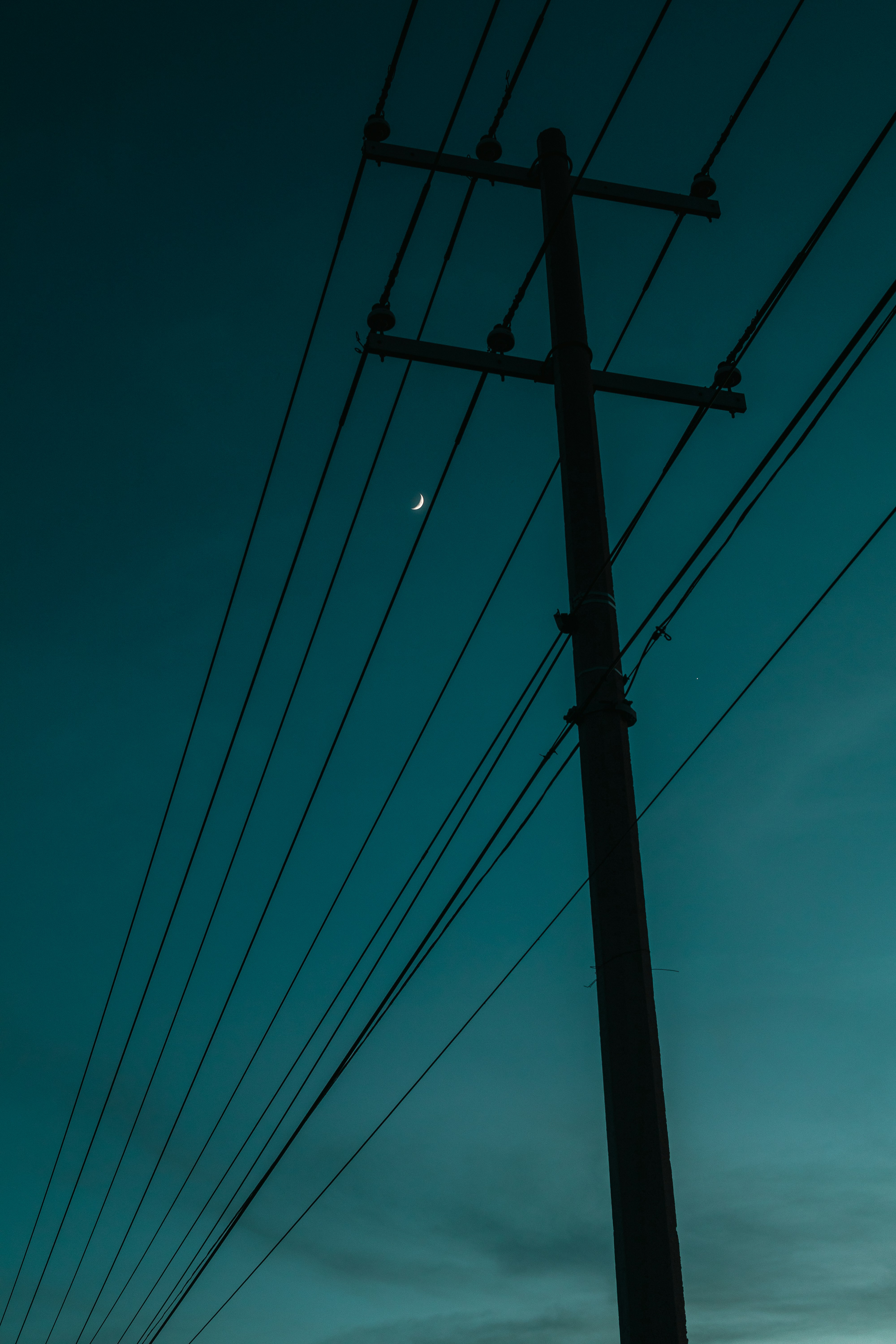 Crescent and Cables: Twilight Dialogues on a Teal Sky
