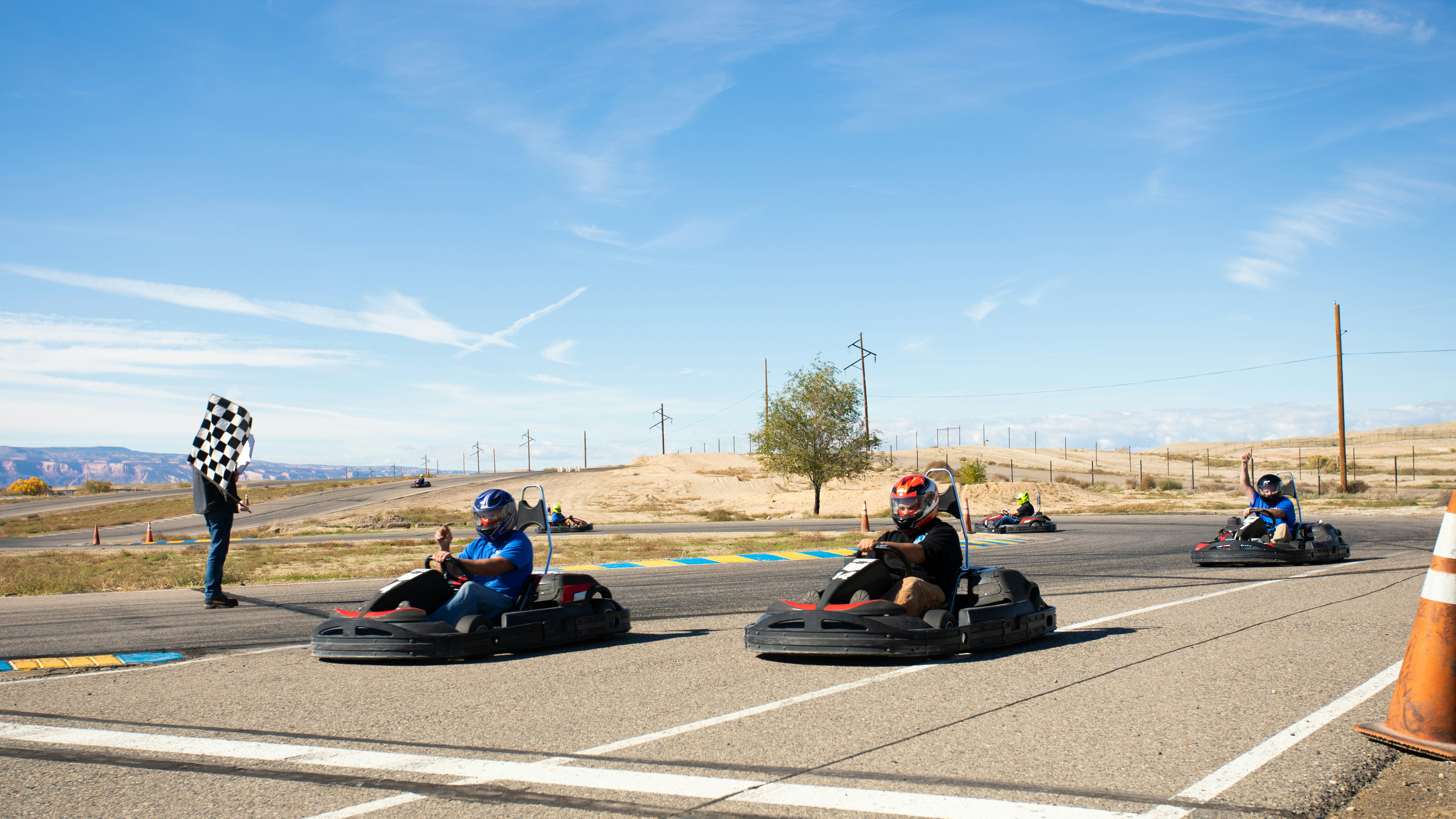 A group of people riding bumper cars down a street photo – Free Car ...