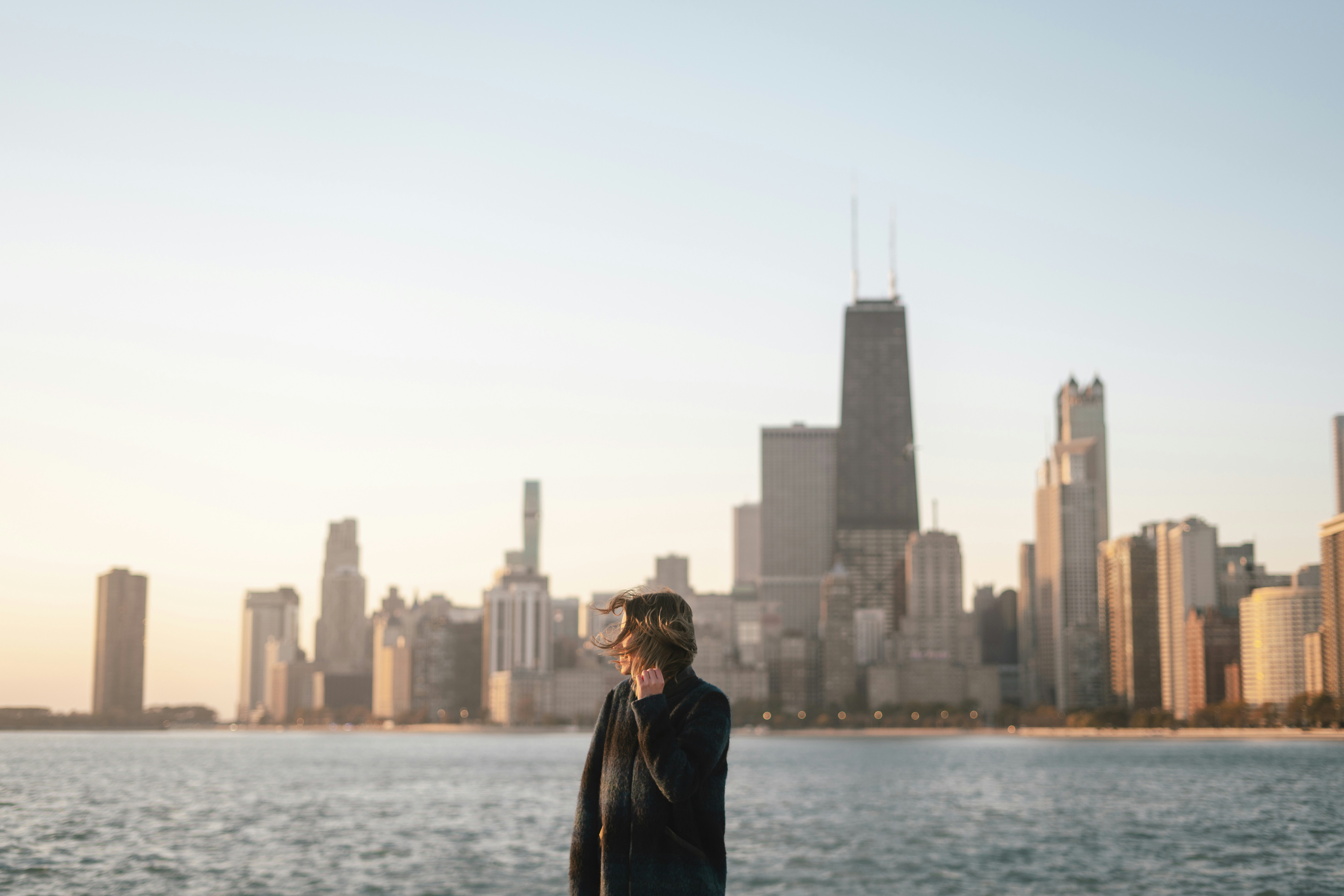 Dusk Silhouette by the Waterfront: solitary figure against a shimmering skyline