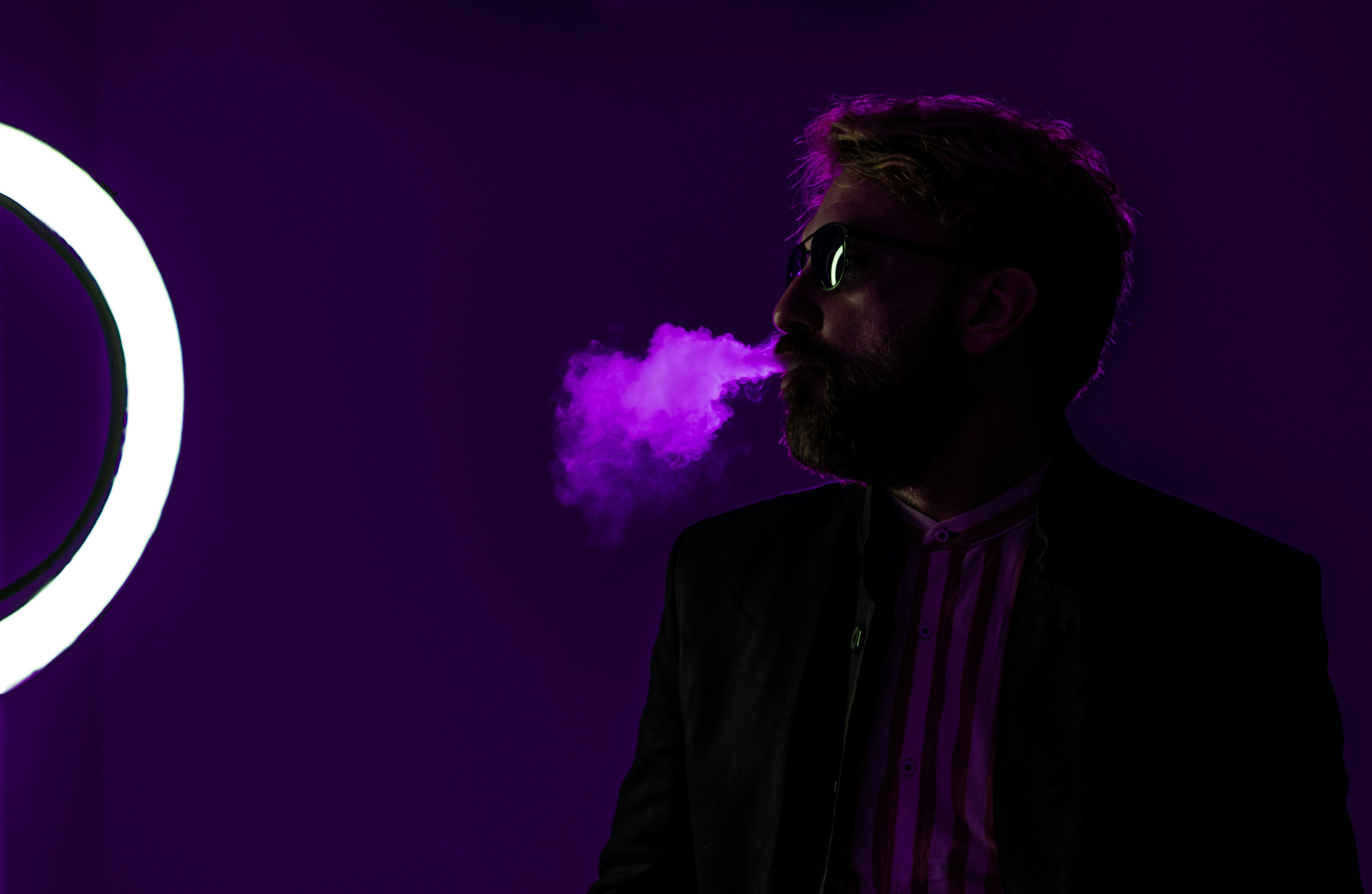 Man in sunglasses vaping