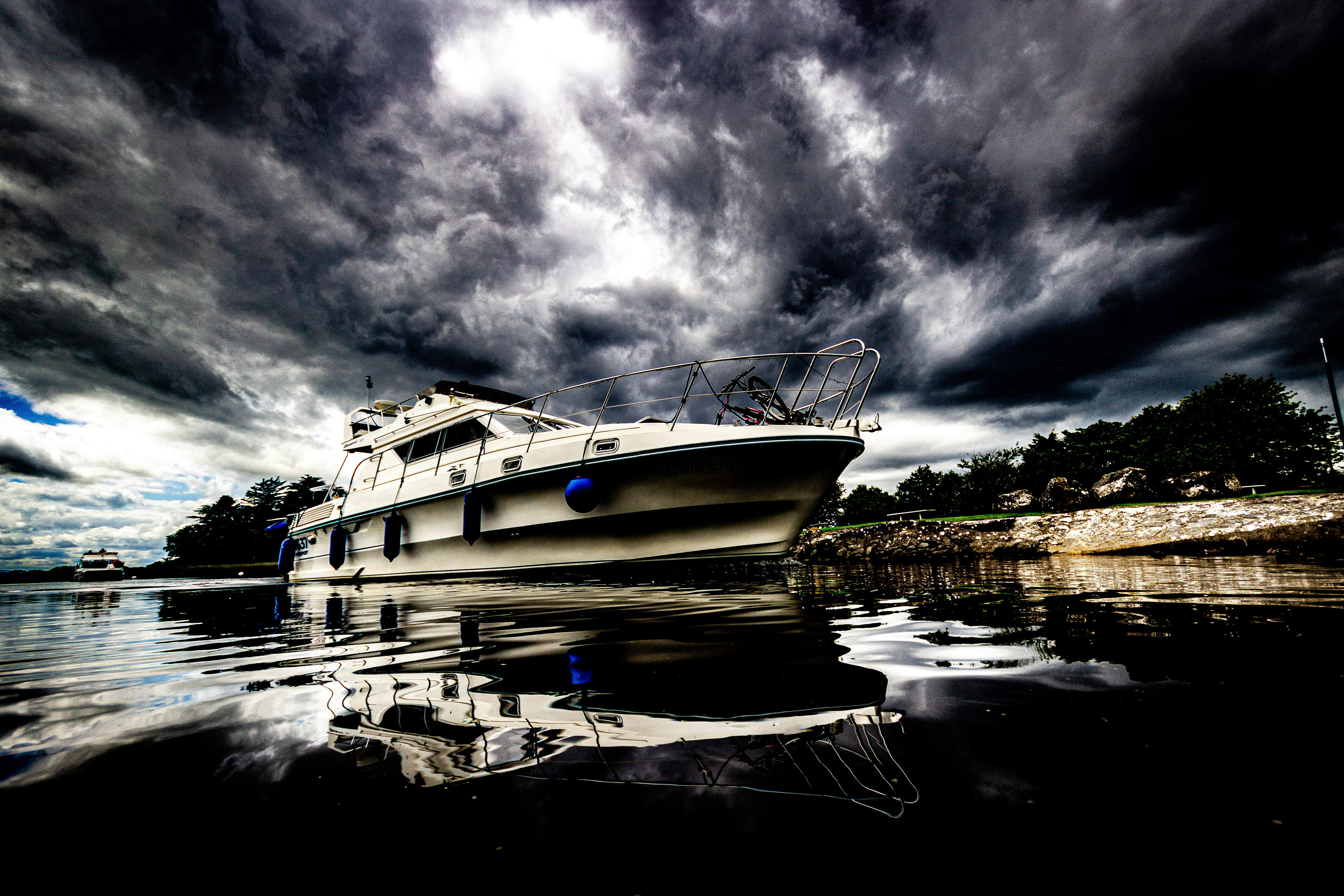 Bow in the Tempest: A Boat Cast Upon a Glassy, Storm-Lit Wake