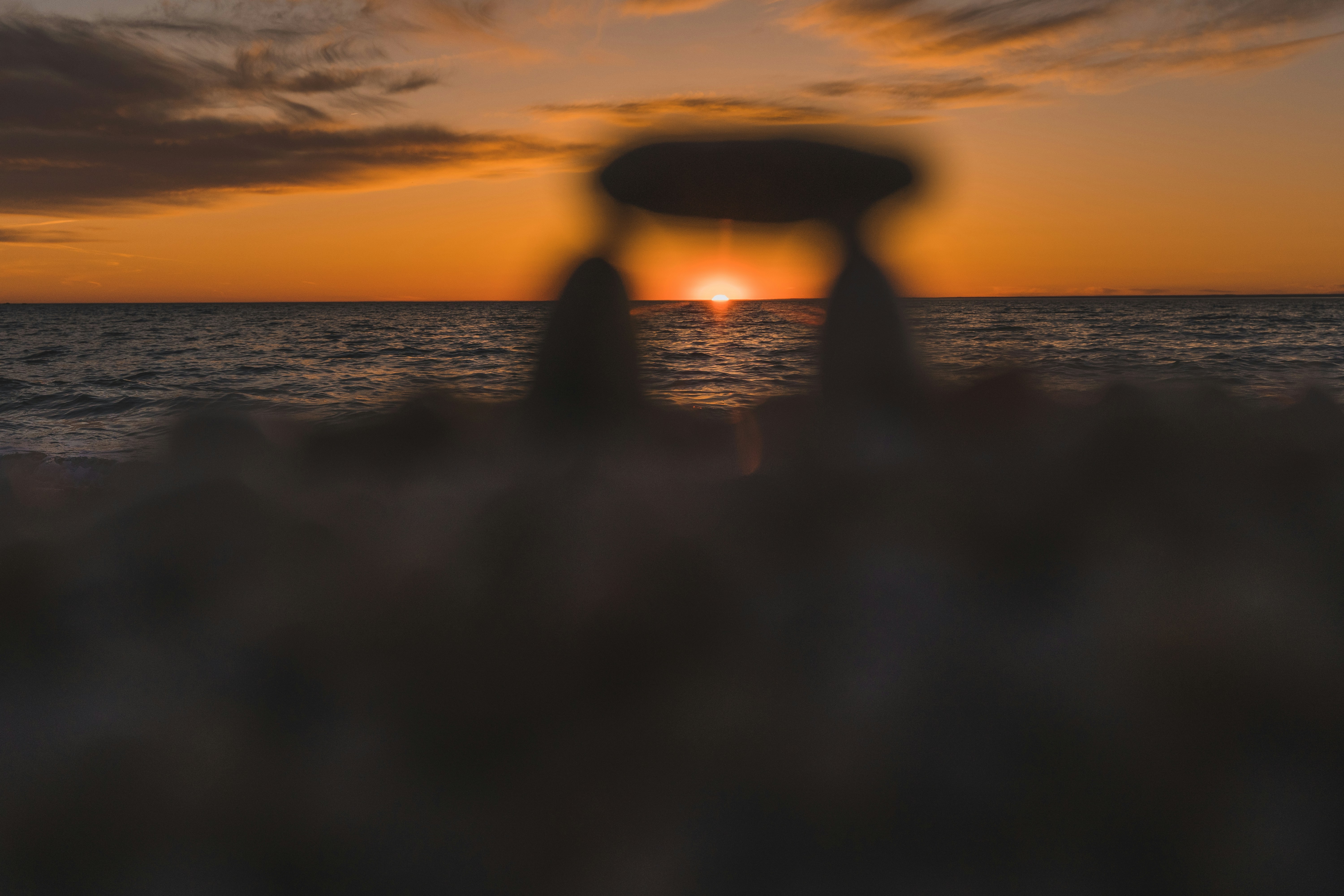 Silhouettes in the Sunset: A Lunar-Soft Moment by the Shore