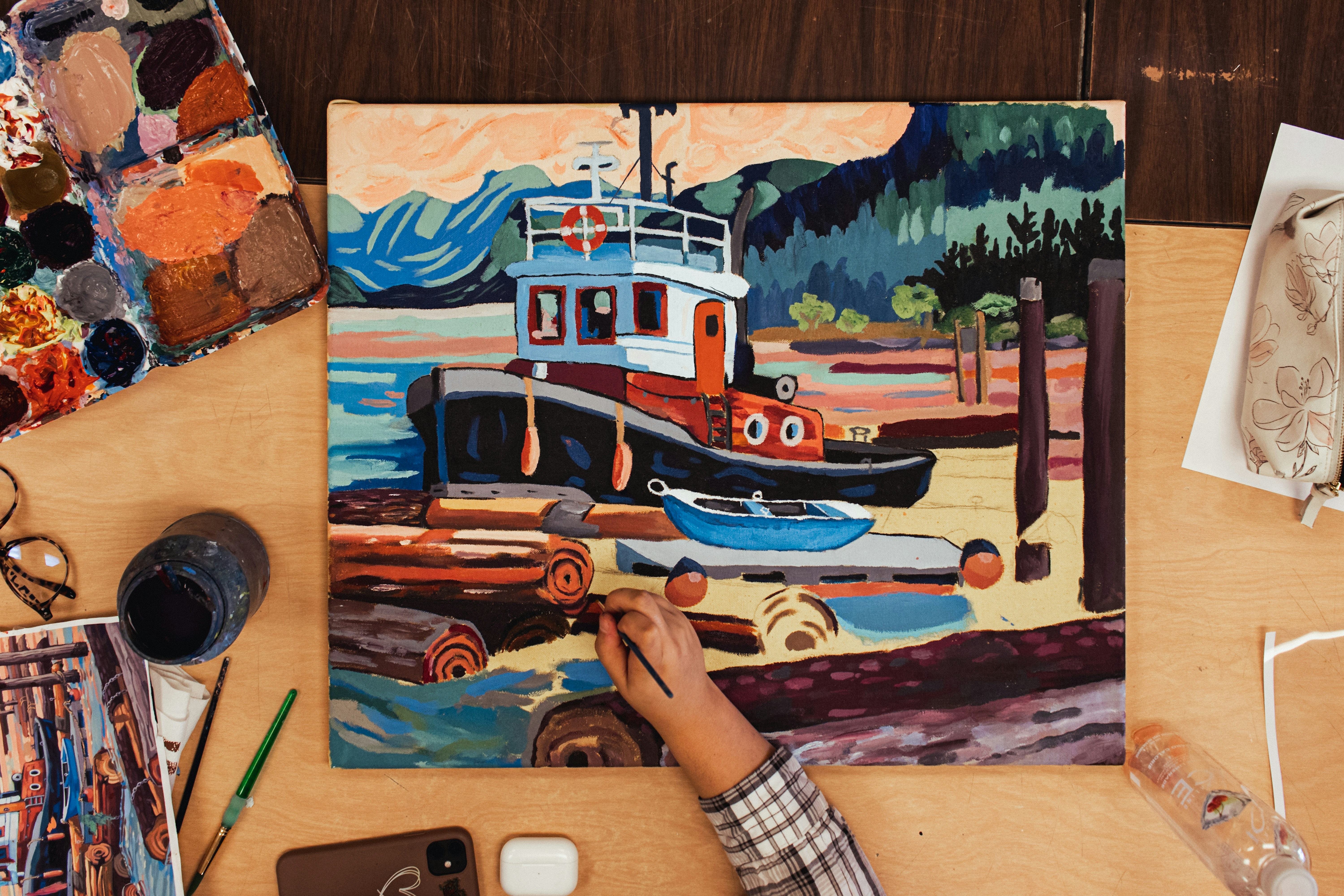 a person is painting a picture of a boat