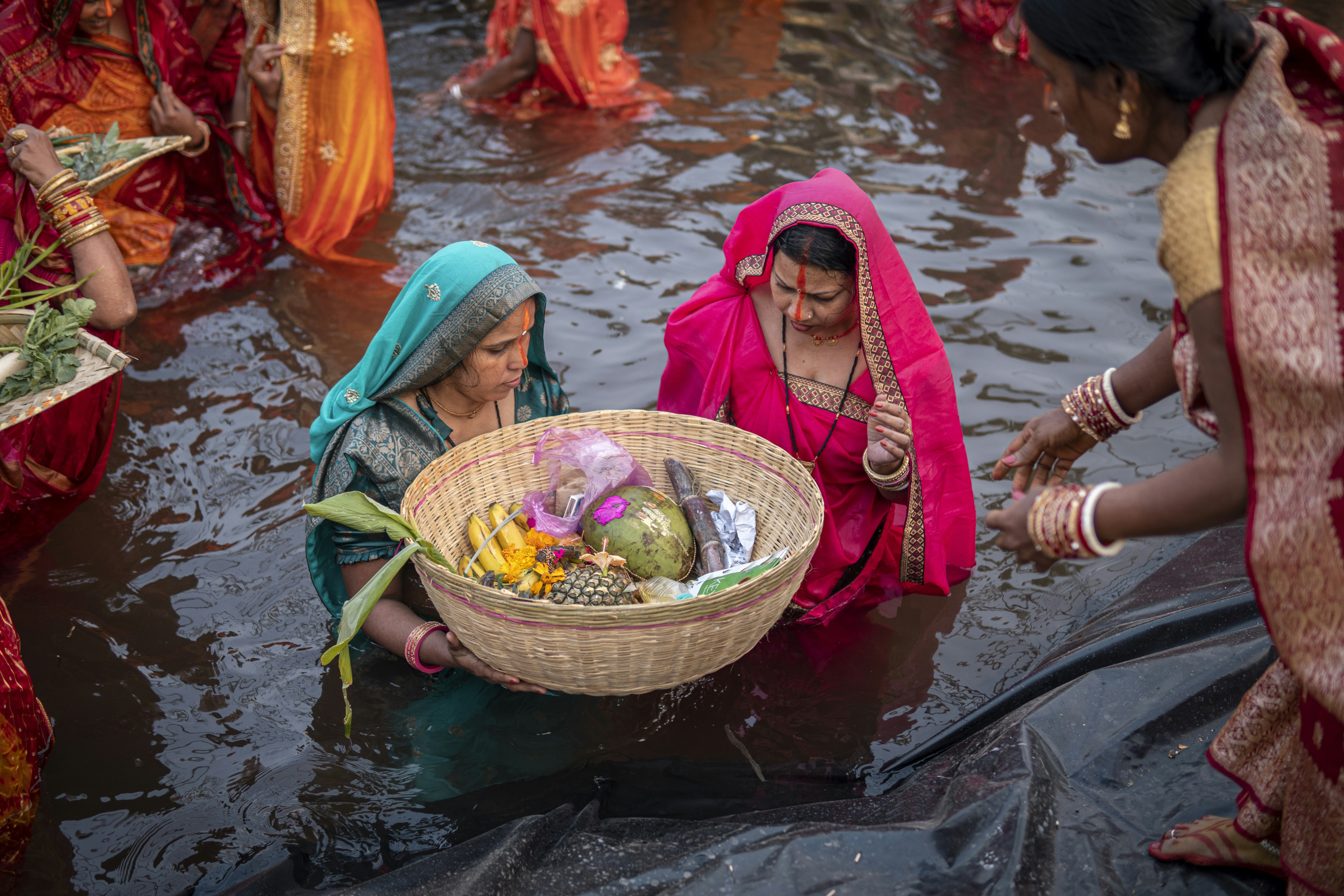 A group of women standing in a flooded area photo – Free Human Image on ...