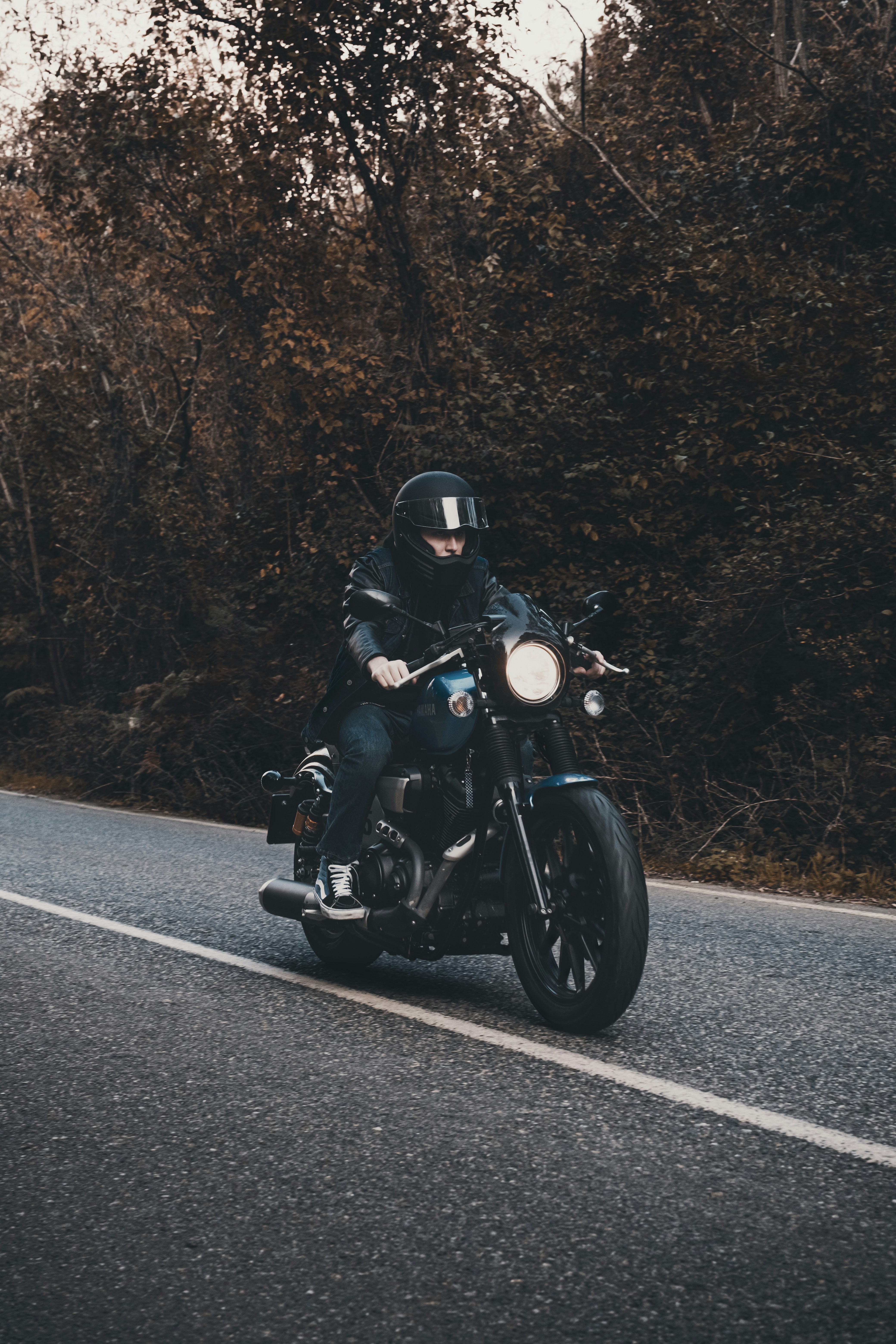 A man riding a motorcycle down a curvy road photo – Free Motorcycle ...