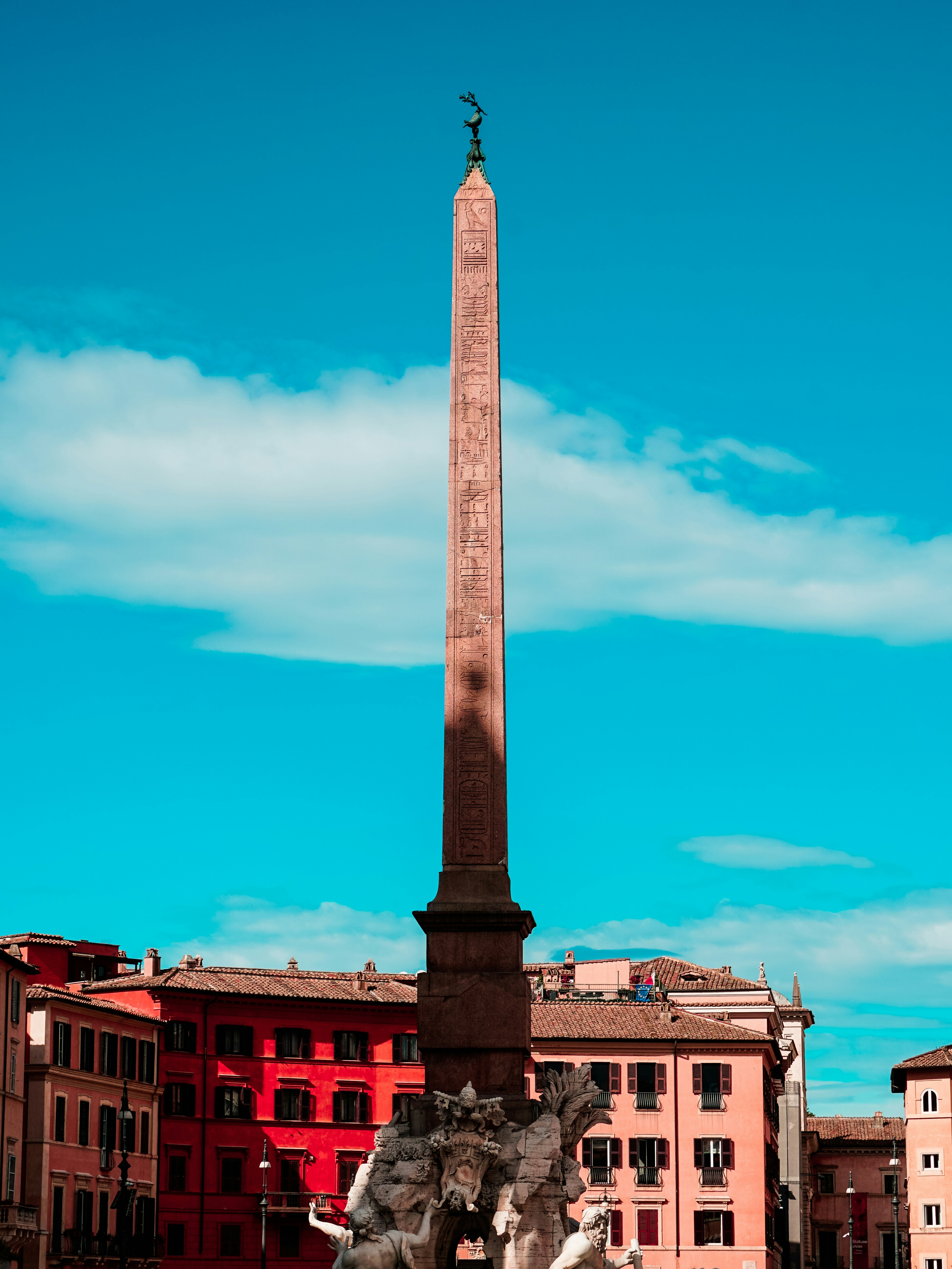 A tall obelisk with a statue in front of it photo – Free Rome Image on ...