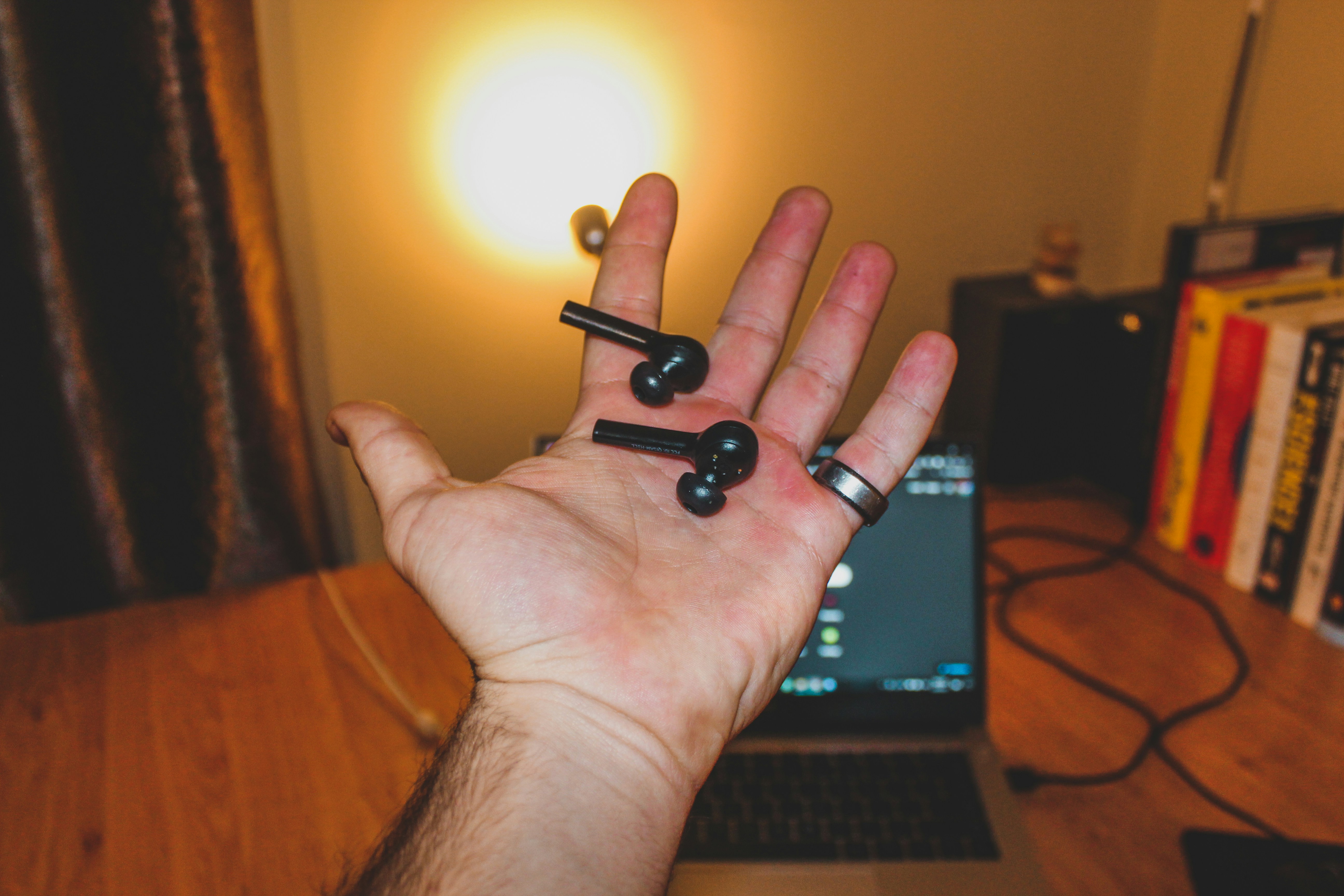 Two Black Orbs on Metal Stems in a Cozy Desk-Lamp Scene
