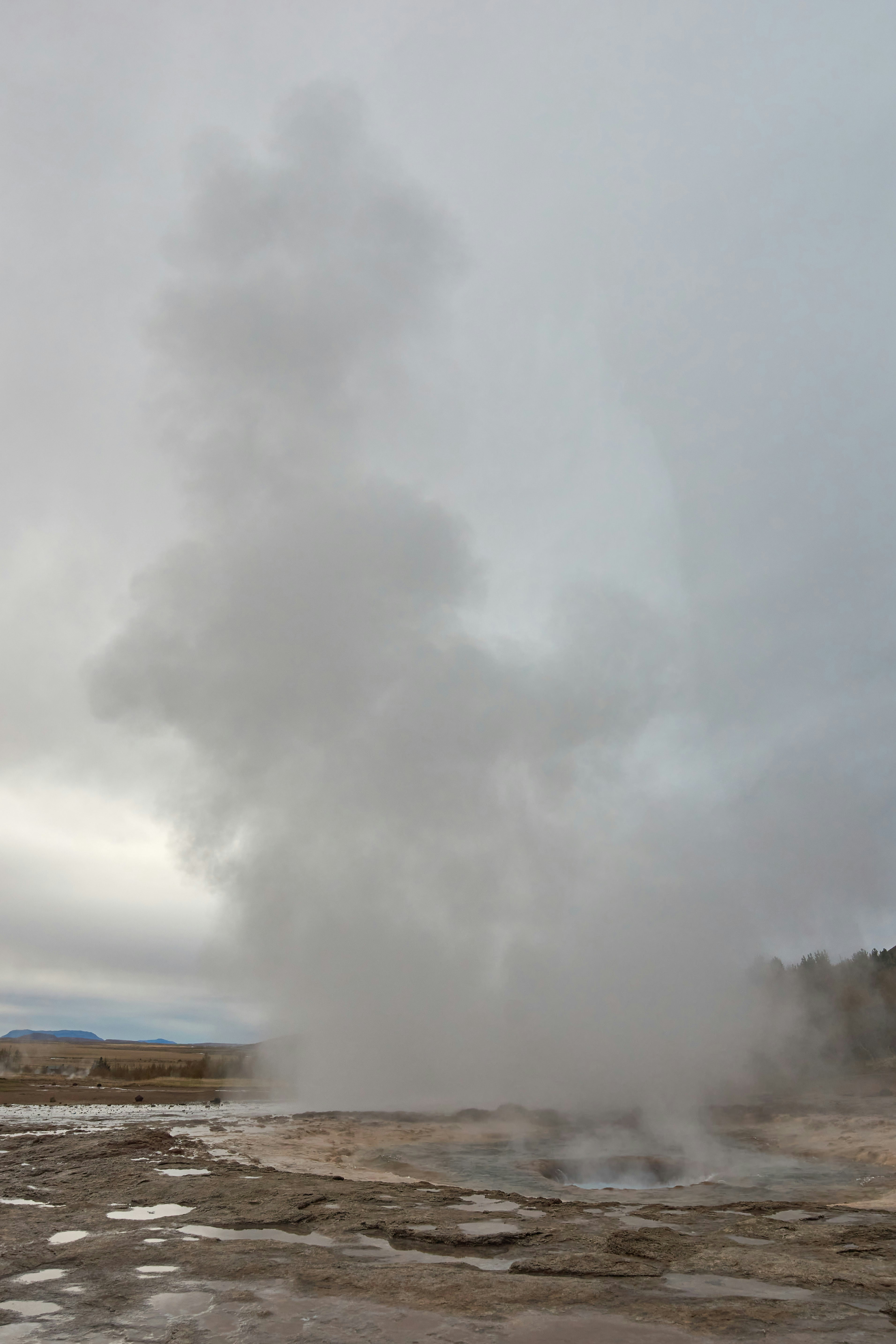 a geyser spewing out steam into the air