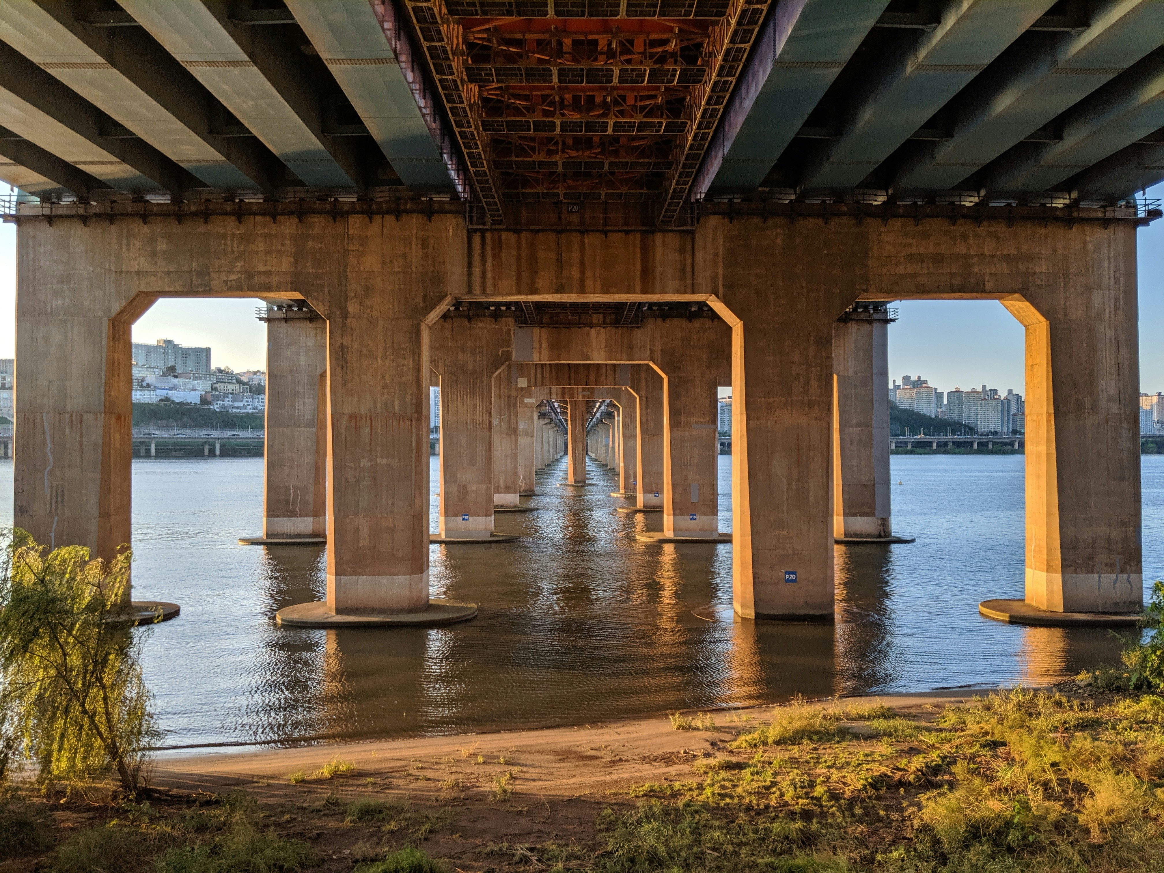 A view of the underside of a bridge over a body of water photo – Free ...