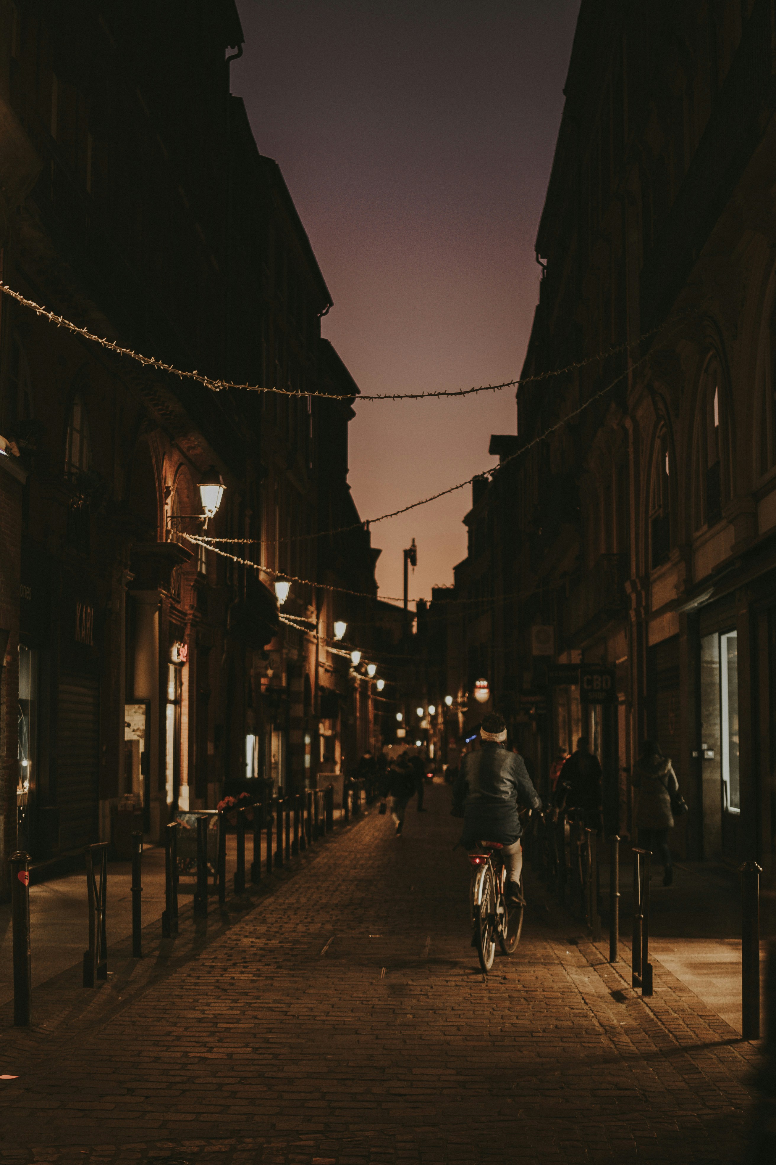 Amber Threads and Quiet Wheels: A Night Ride Through the Cobblestone Alley