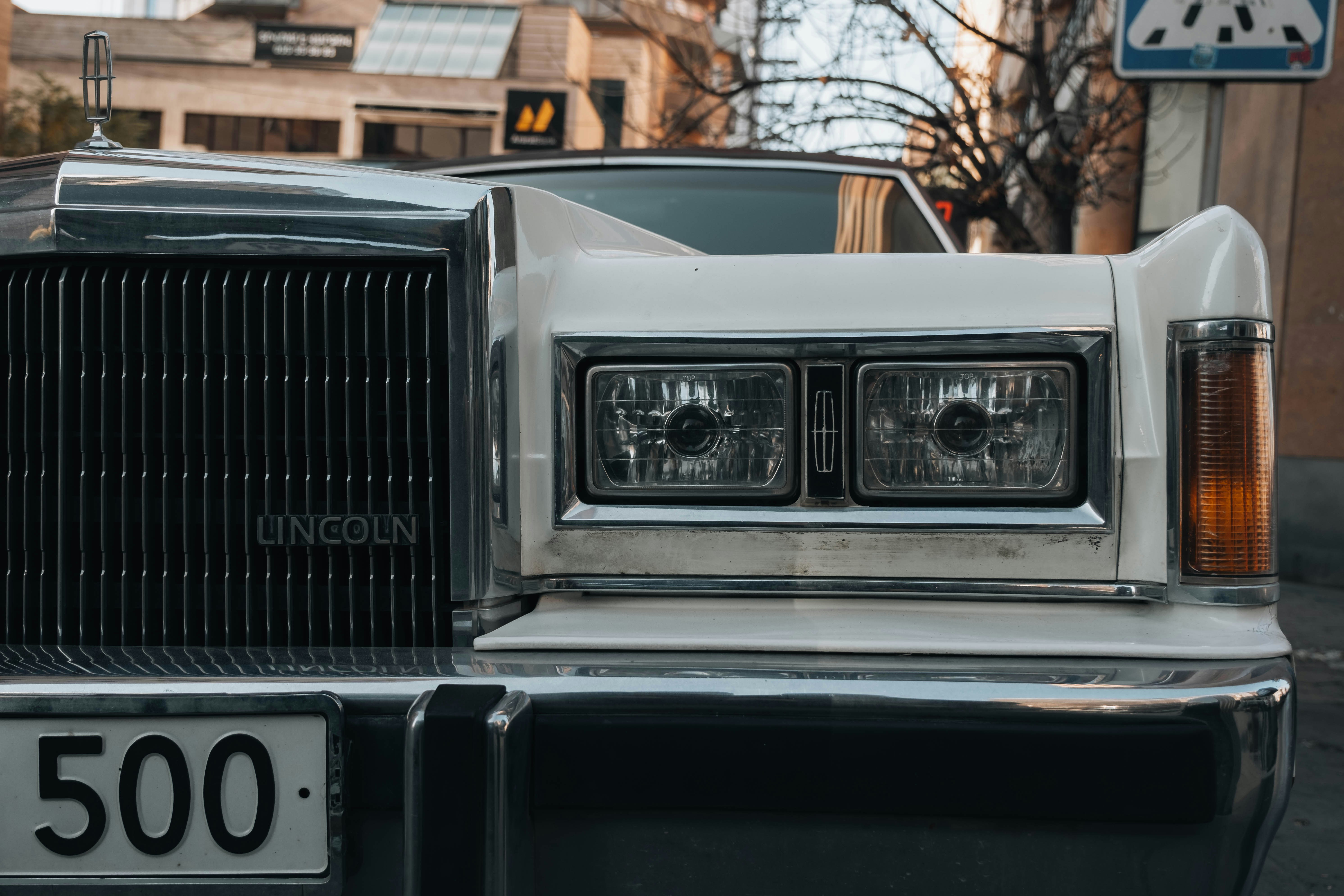 Twin Headlamps in Chrome: Lincoln on a Quiet City Block