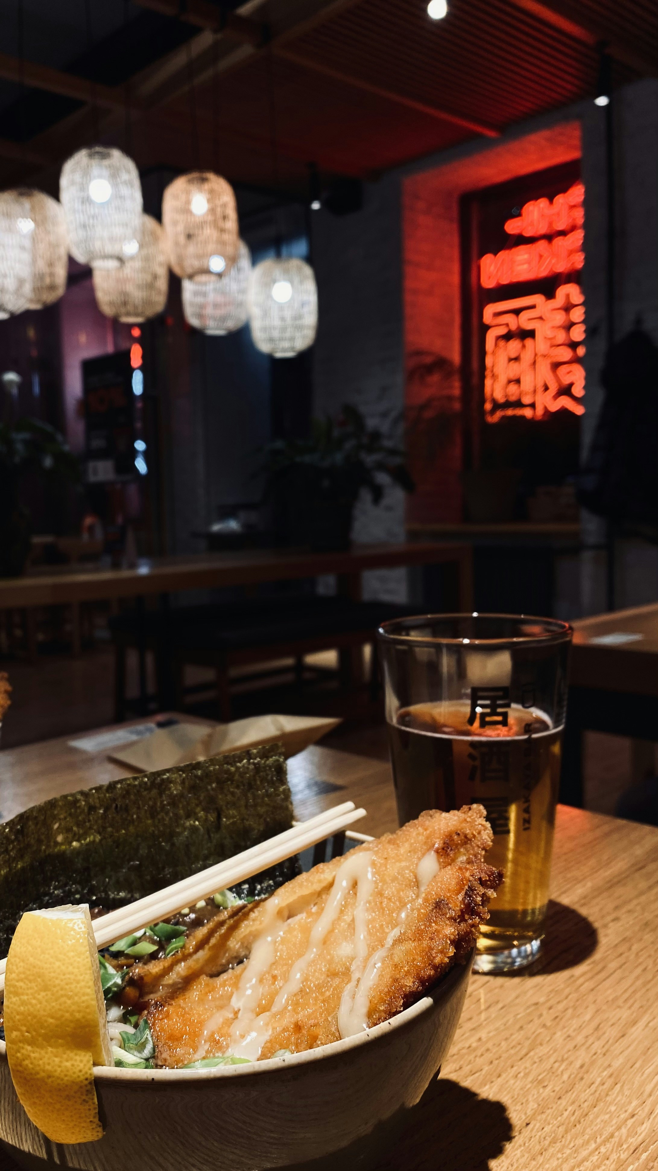 a bowl of food and a glass of beer on a table