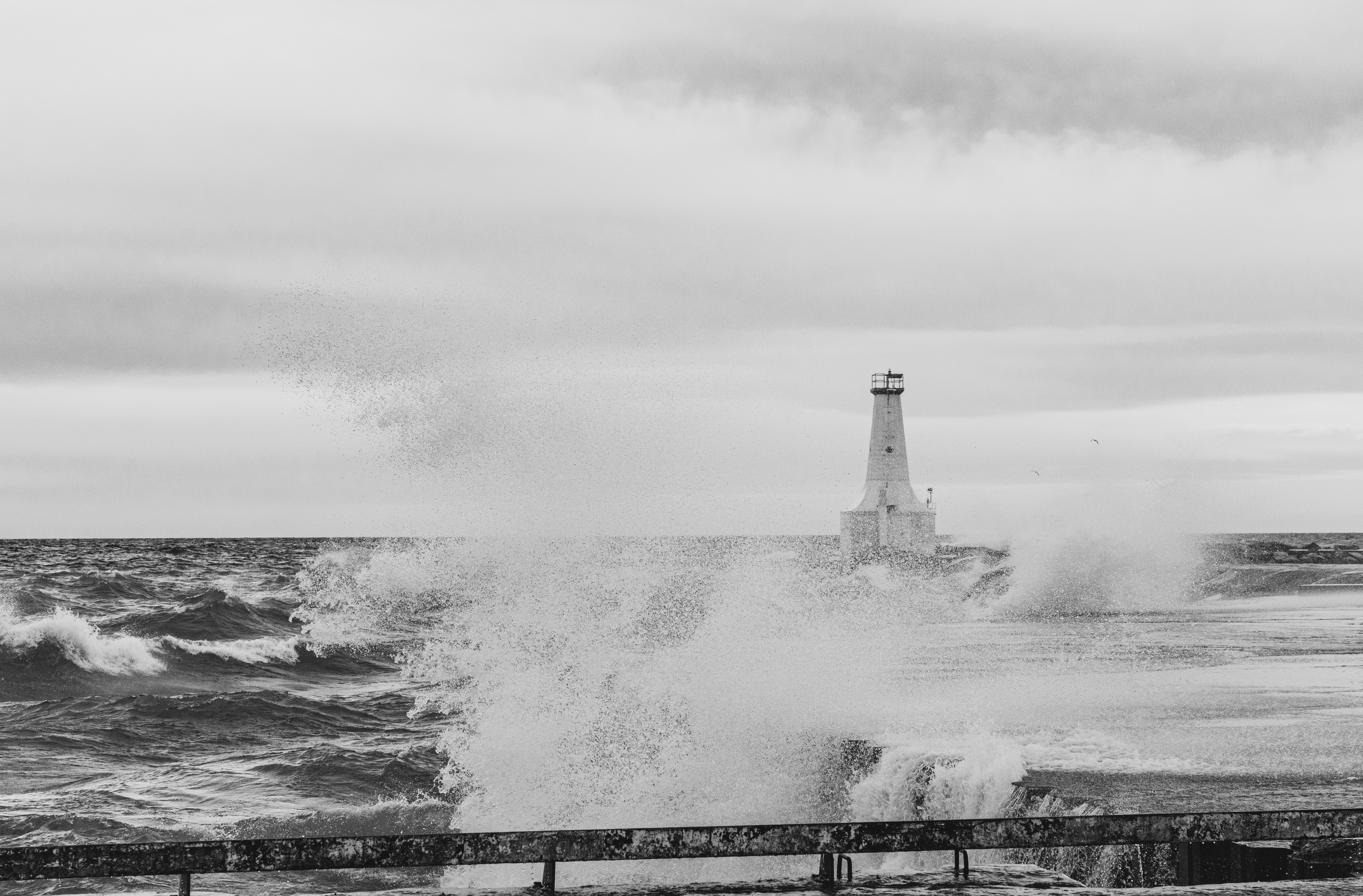 Beacon Against the Breakers: A Monochrome Coastal Moment