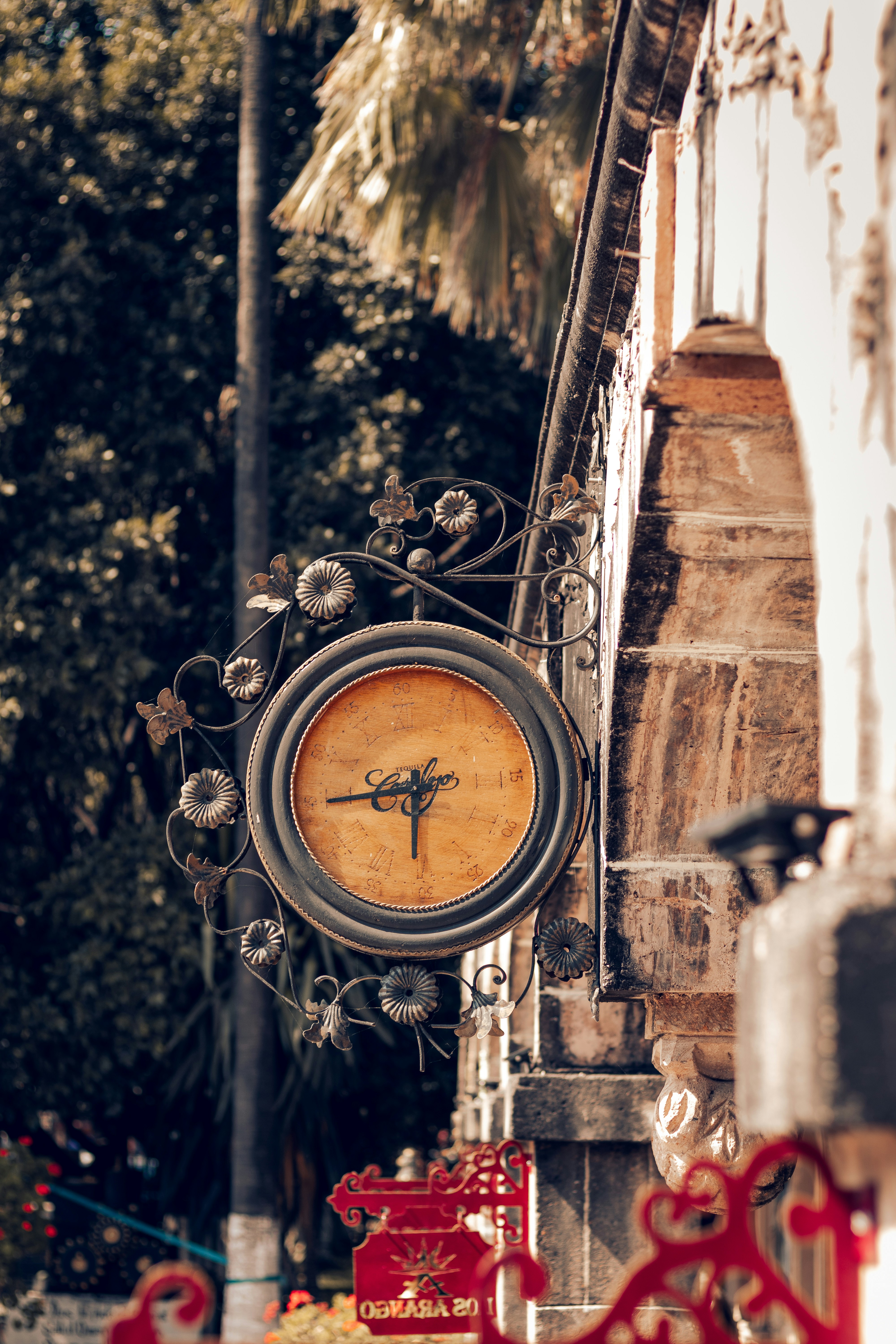 Ornate Clock Adorned Facade: A Walled Detail in Warm Sepia Tones