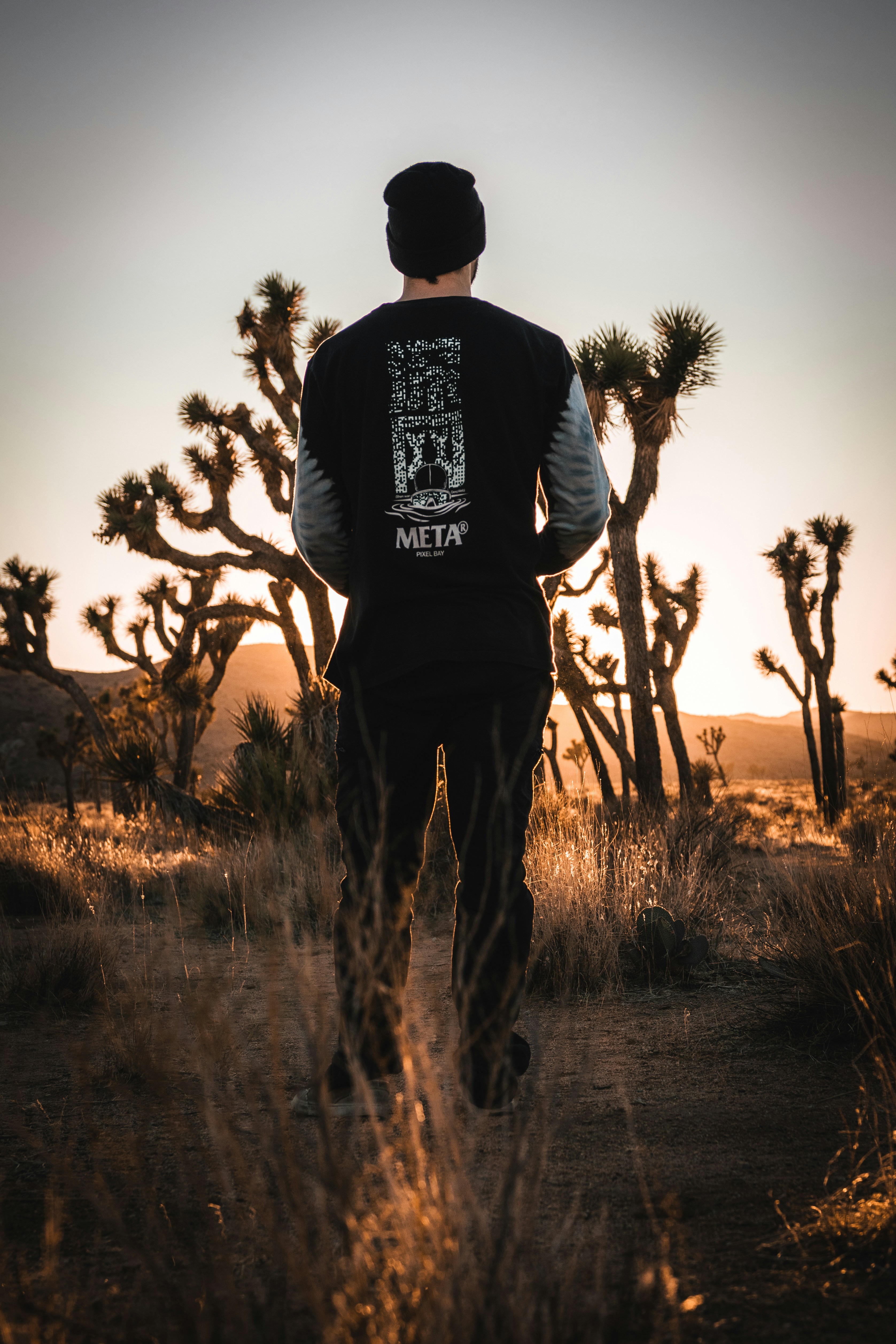 A man standing next to a tree photo – Free Joshua tree Image on Unsplash