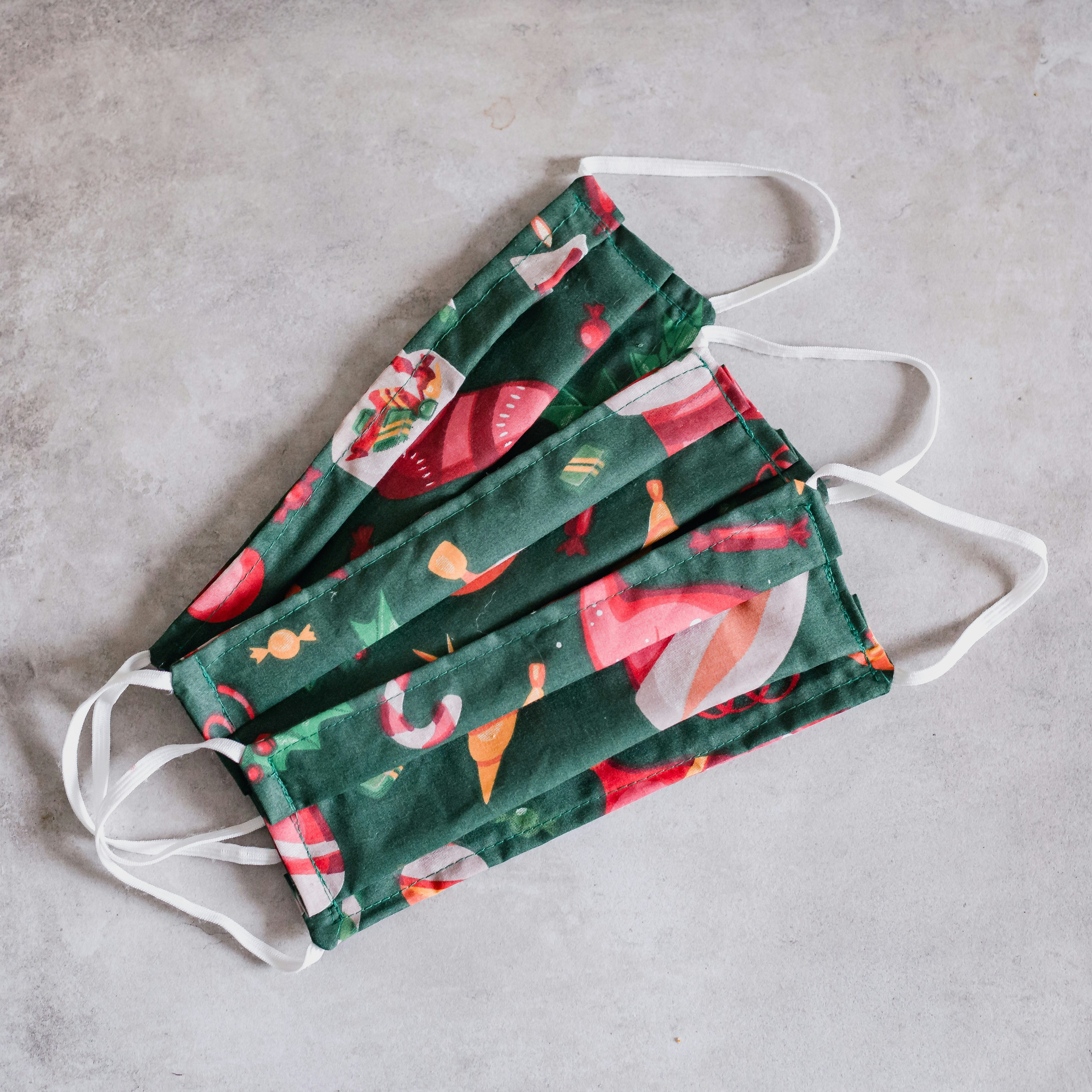 A pair of face masks on a concrete surface photo – Free Accessories ...