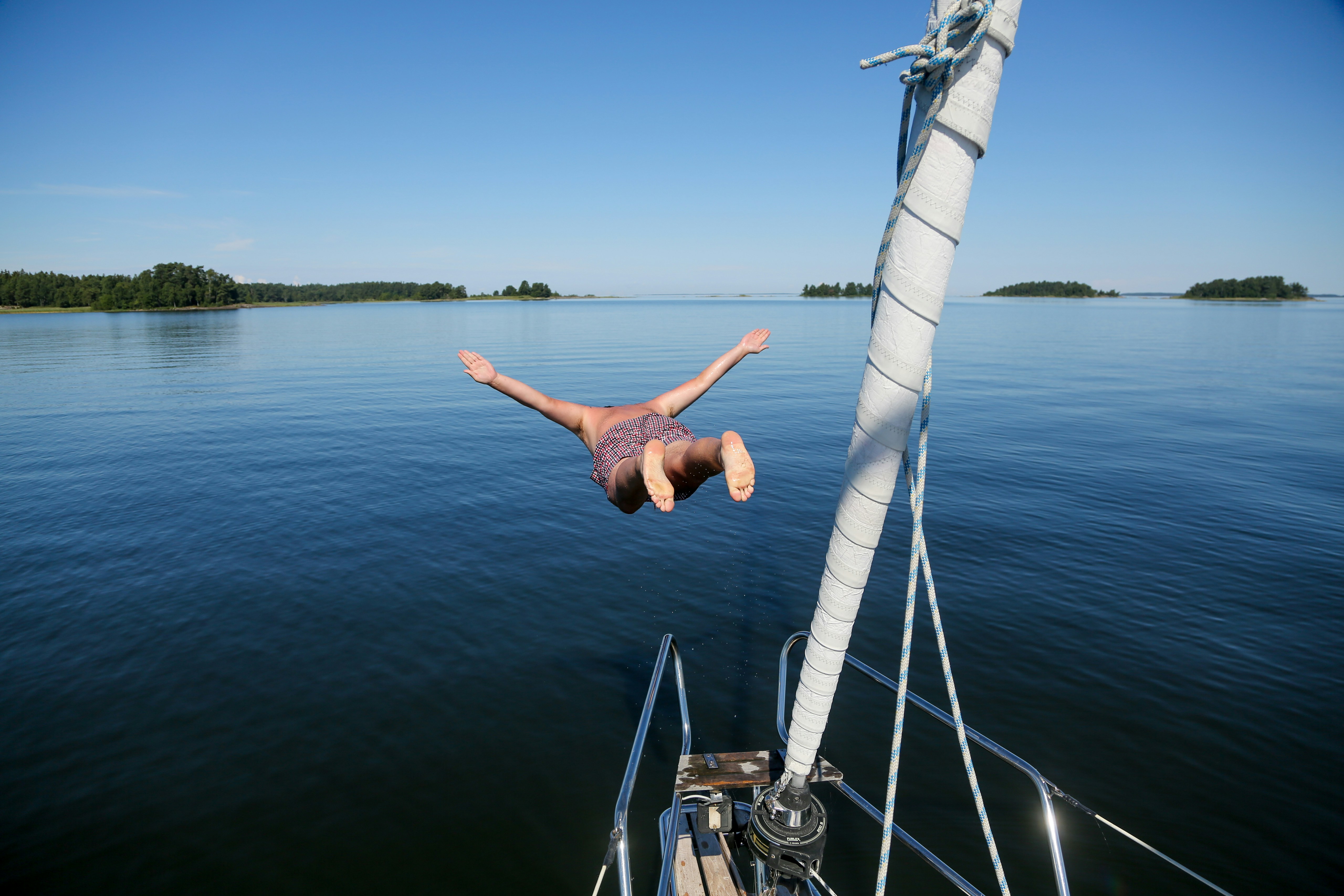 A man diving into the water from a boat photo – Free Vänern Image on ...