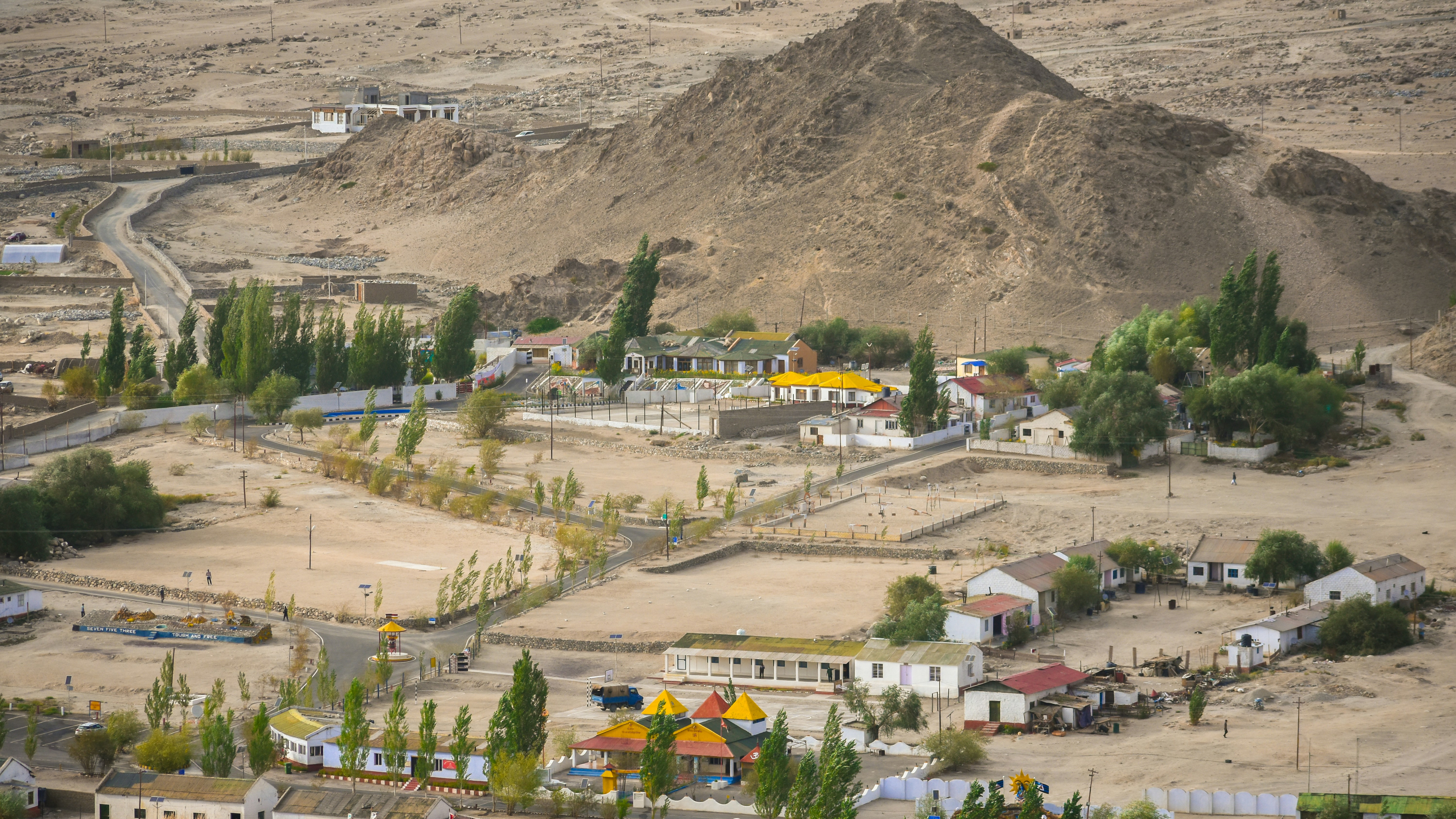 Desert Village: Painted Roofs Rise Above Dusty Lanes