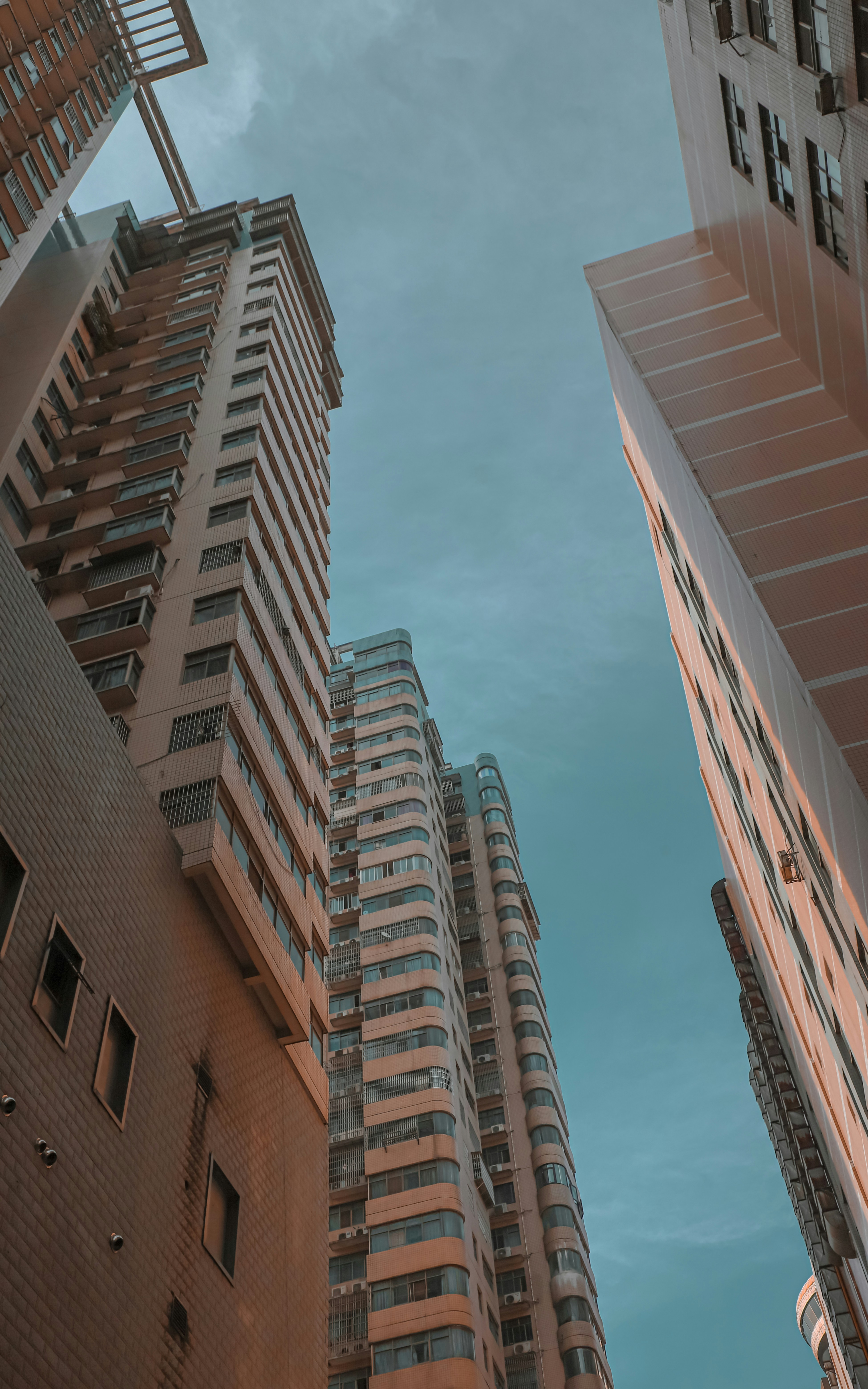 A couple of tall buildings next to each other photo – Free Blue Image ...