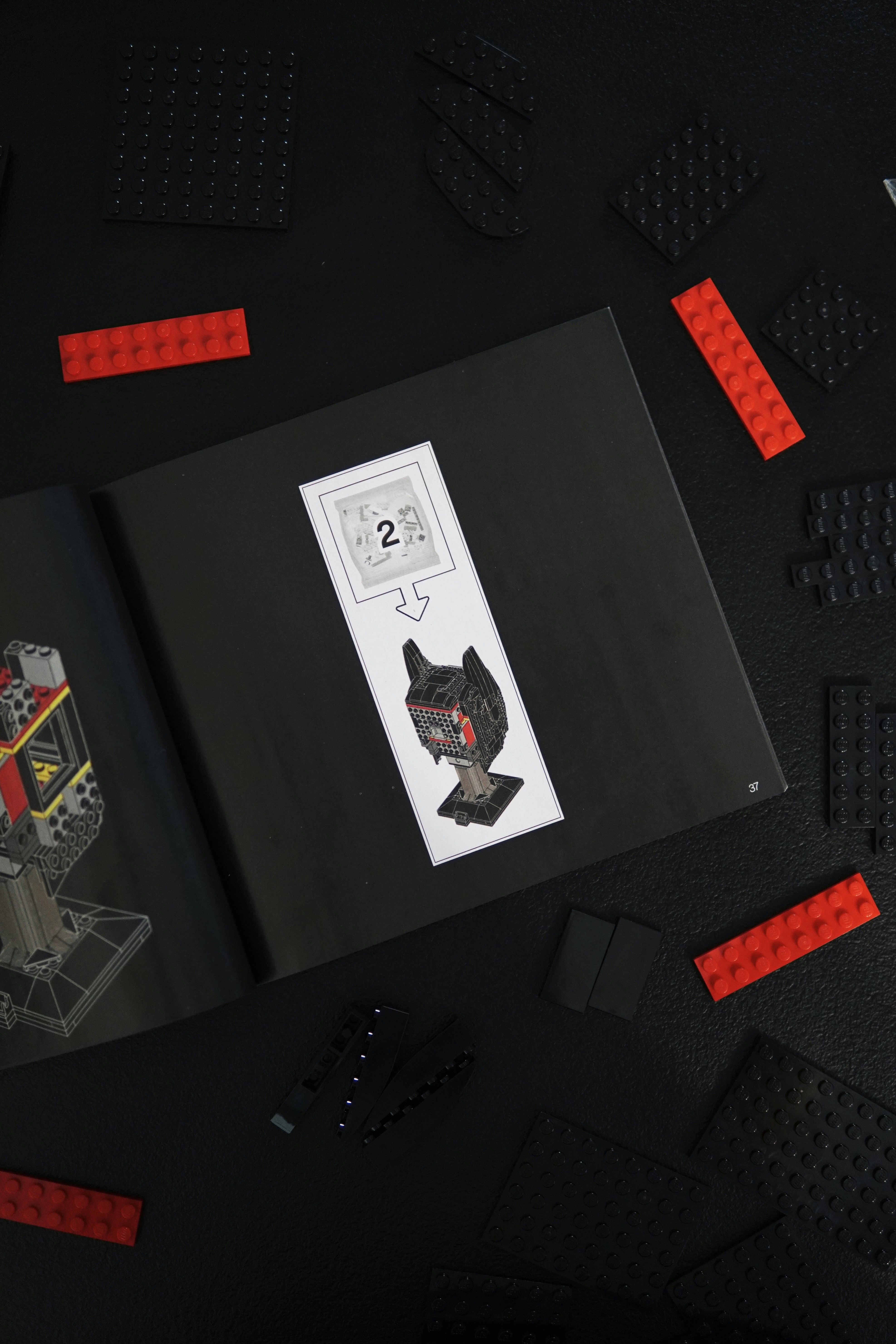 Instruction page featuring a step in a building process alongside scattered building blocks in various colors. 
