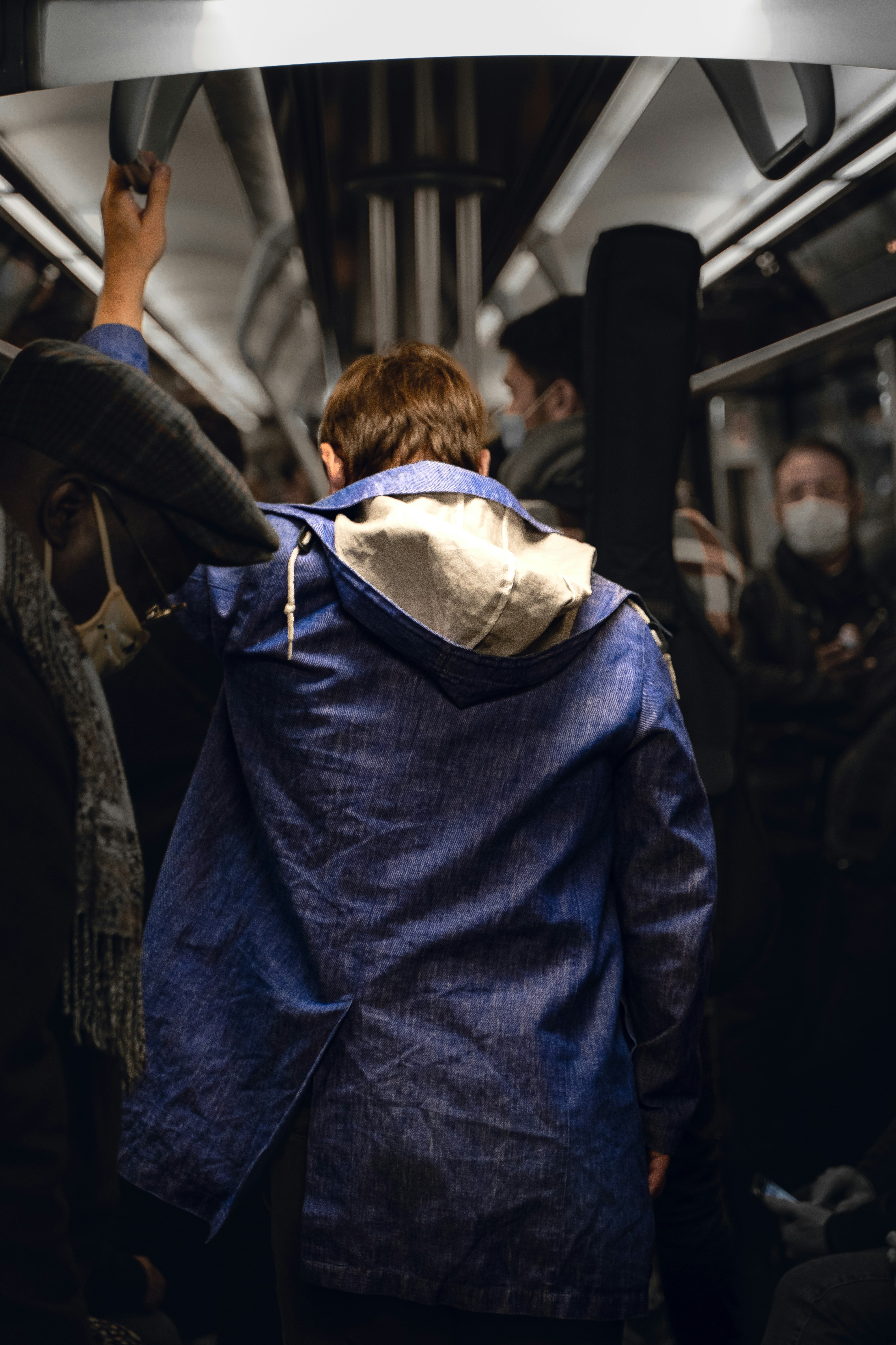 a man in a blue jacket on a subway