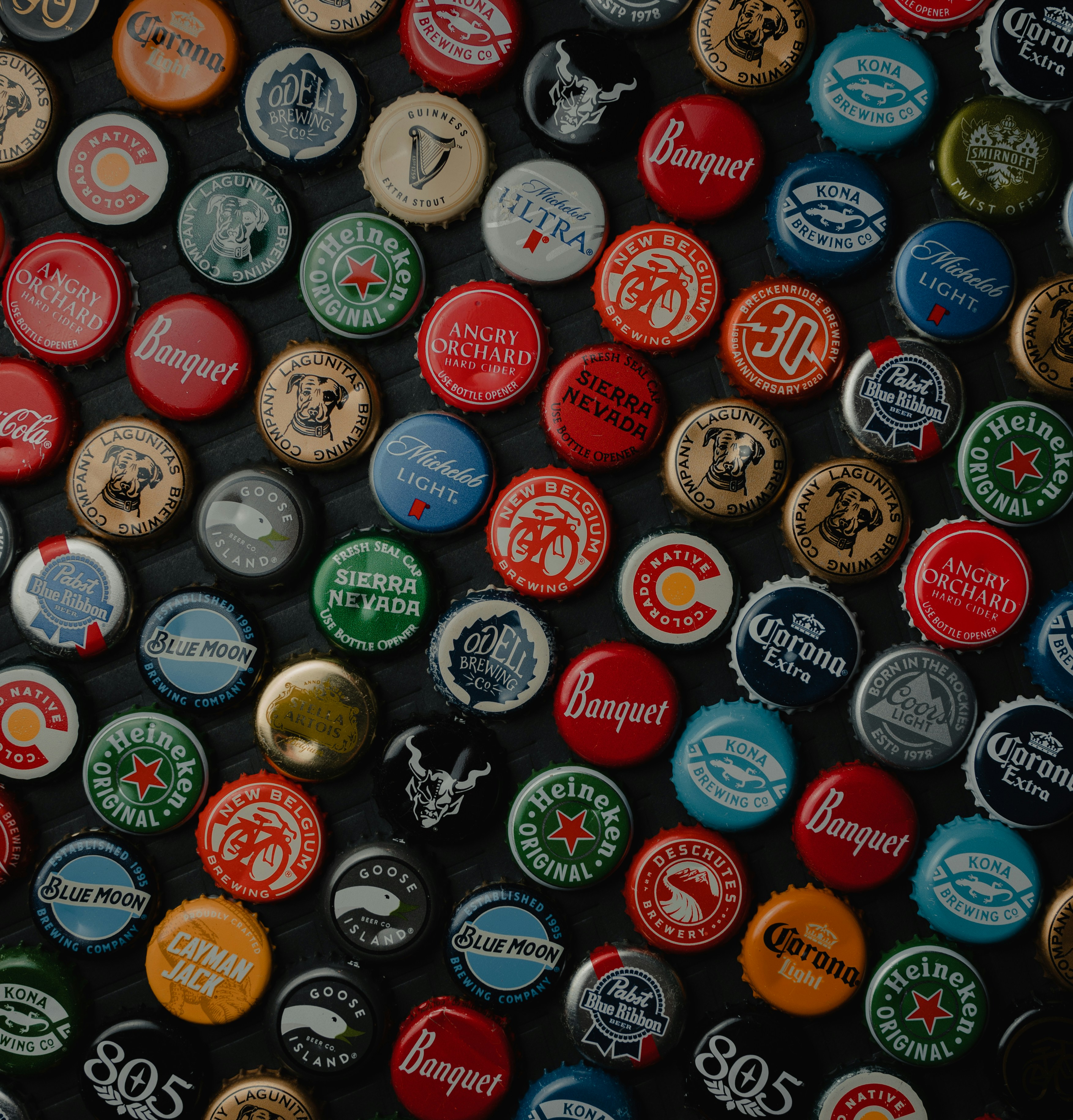 A bunch of beer bottle caps sitting on top of each other photo – Free ...
