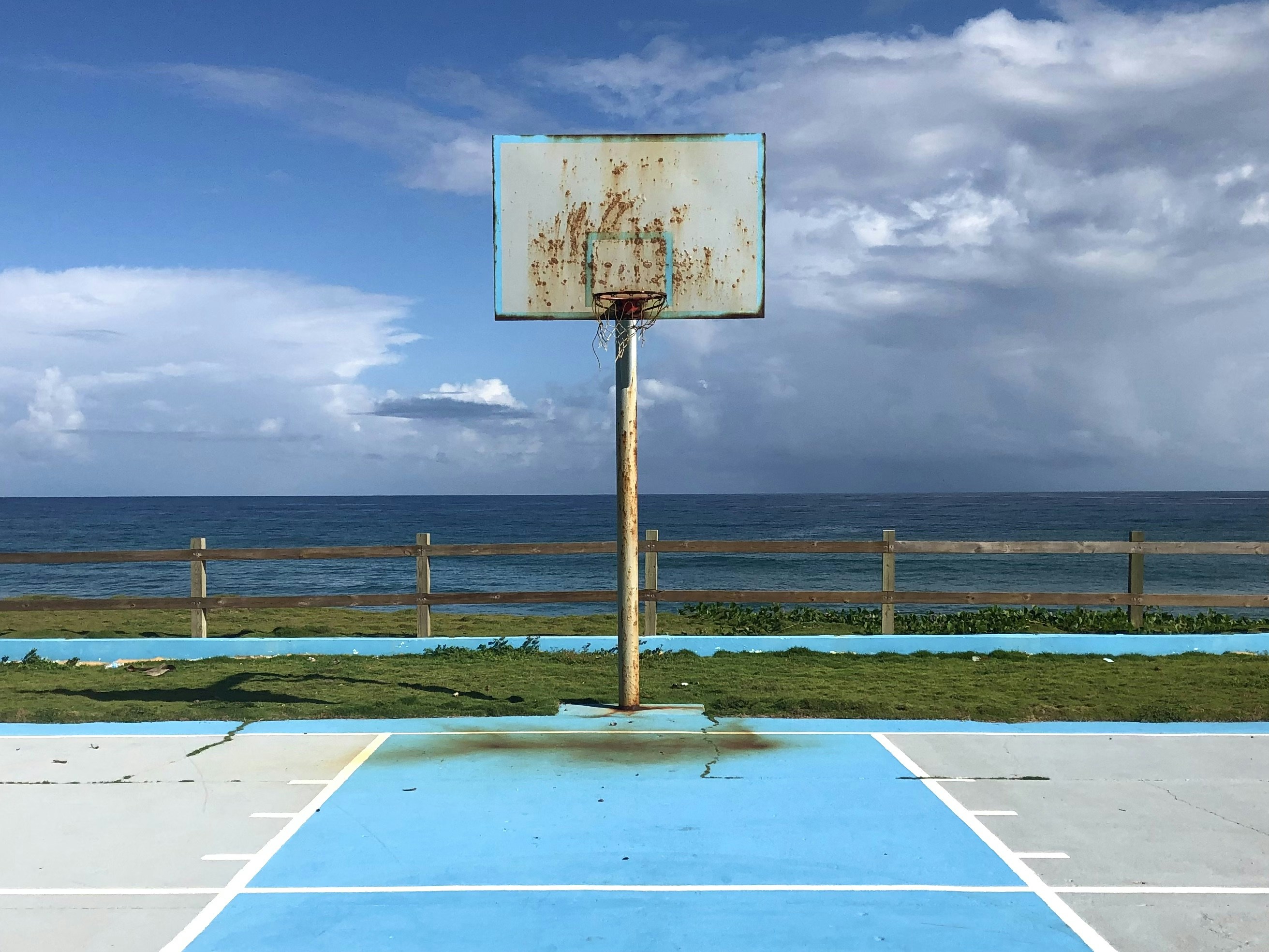 A basketball court in front of a body of water photo – Free Arecibo ...