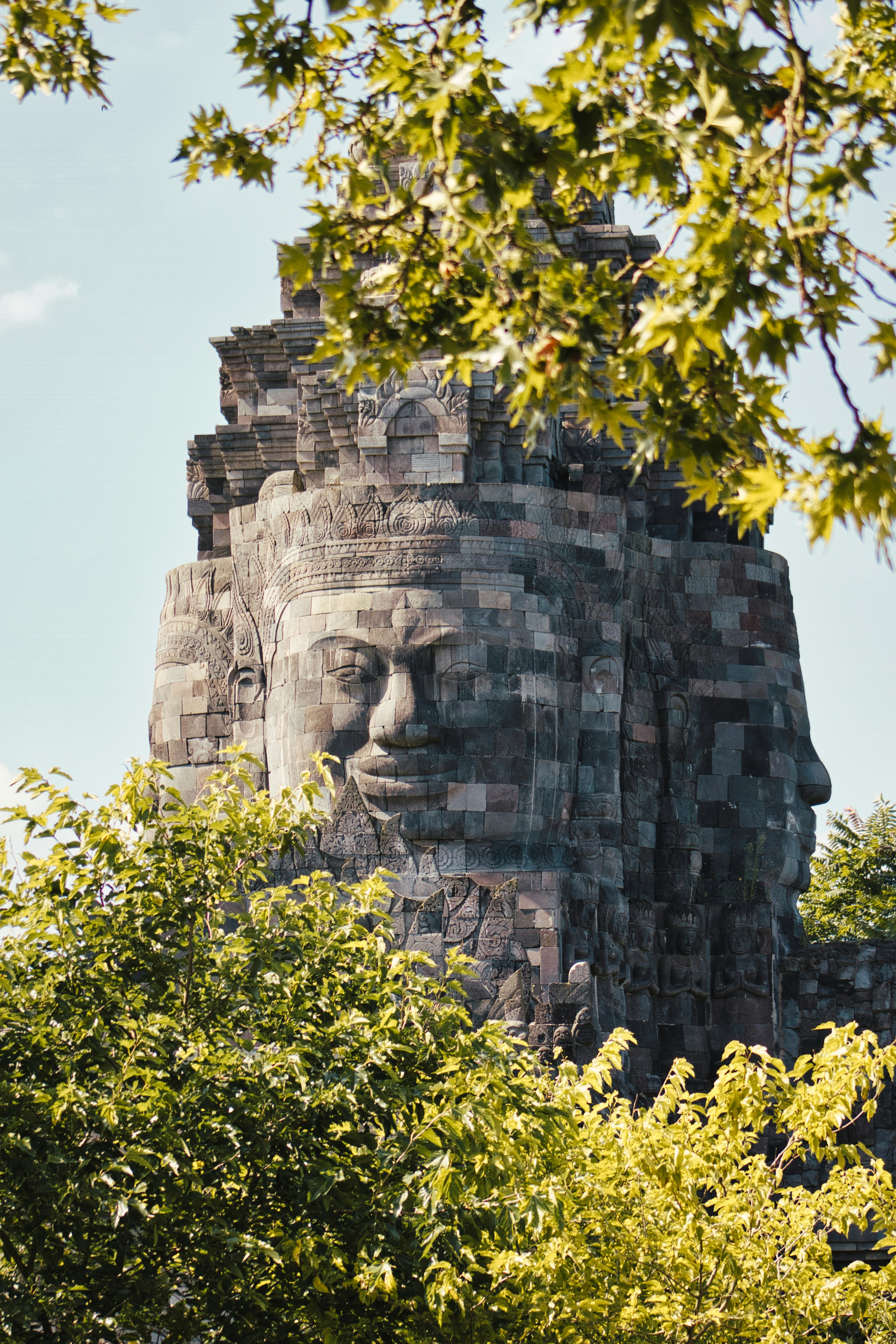 A statue of a man made out of bricks surrounded by trees photo – Free ...