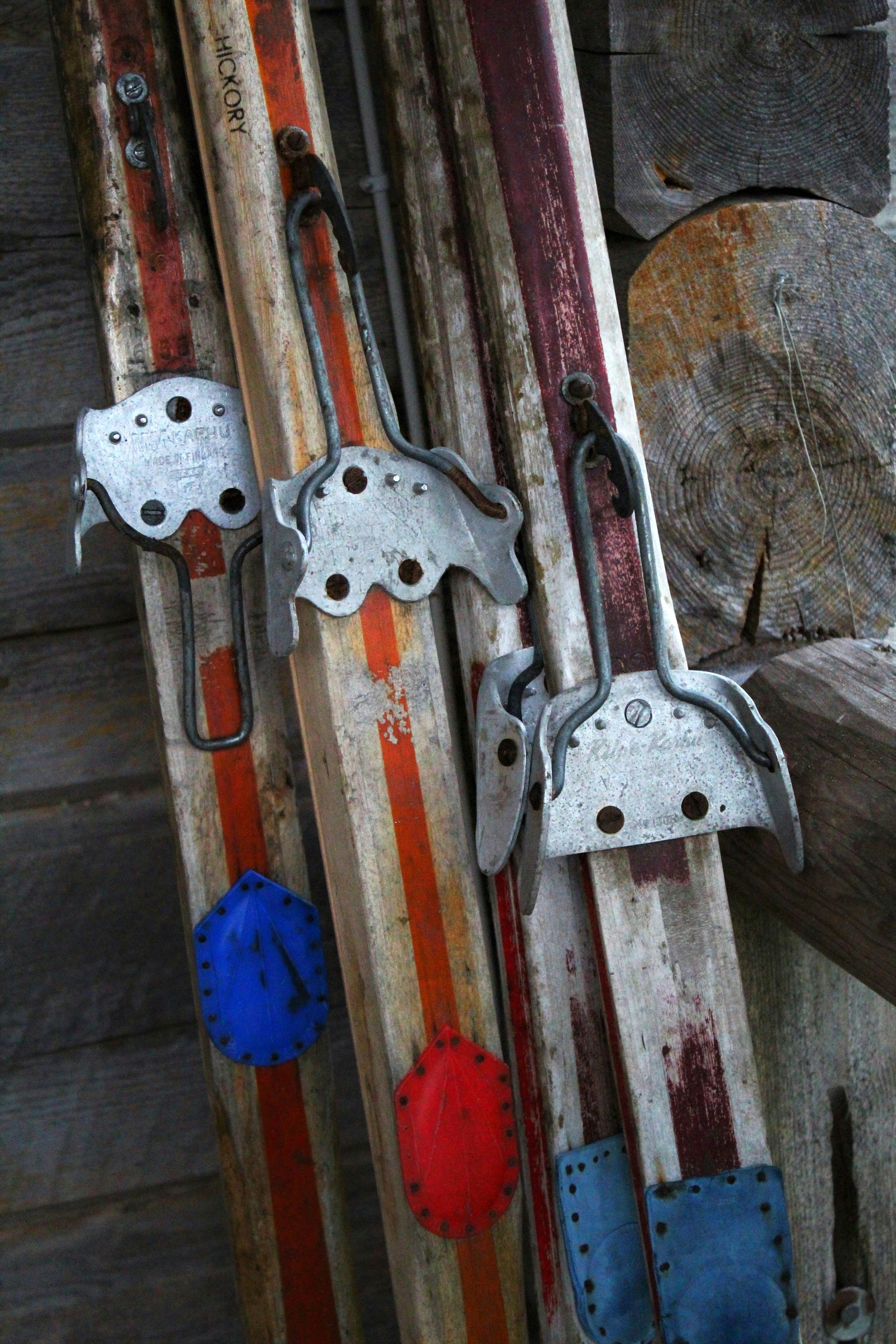 Timeworn Stripes and Steel: Bindings on Weathered Wooden Skis