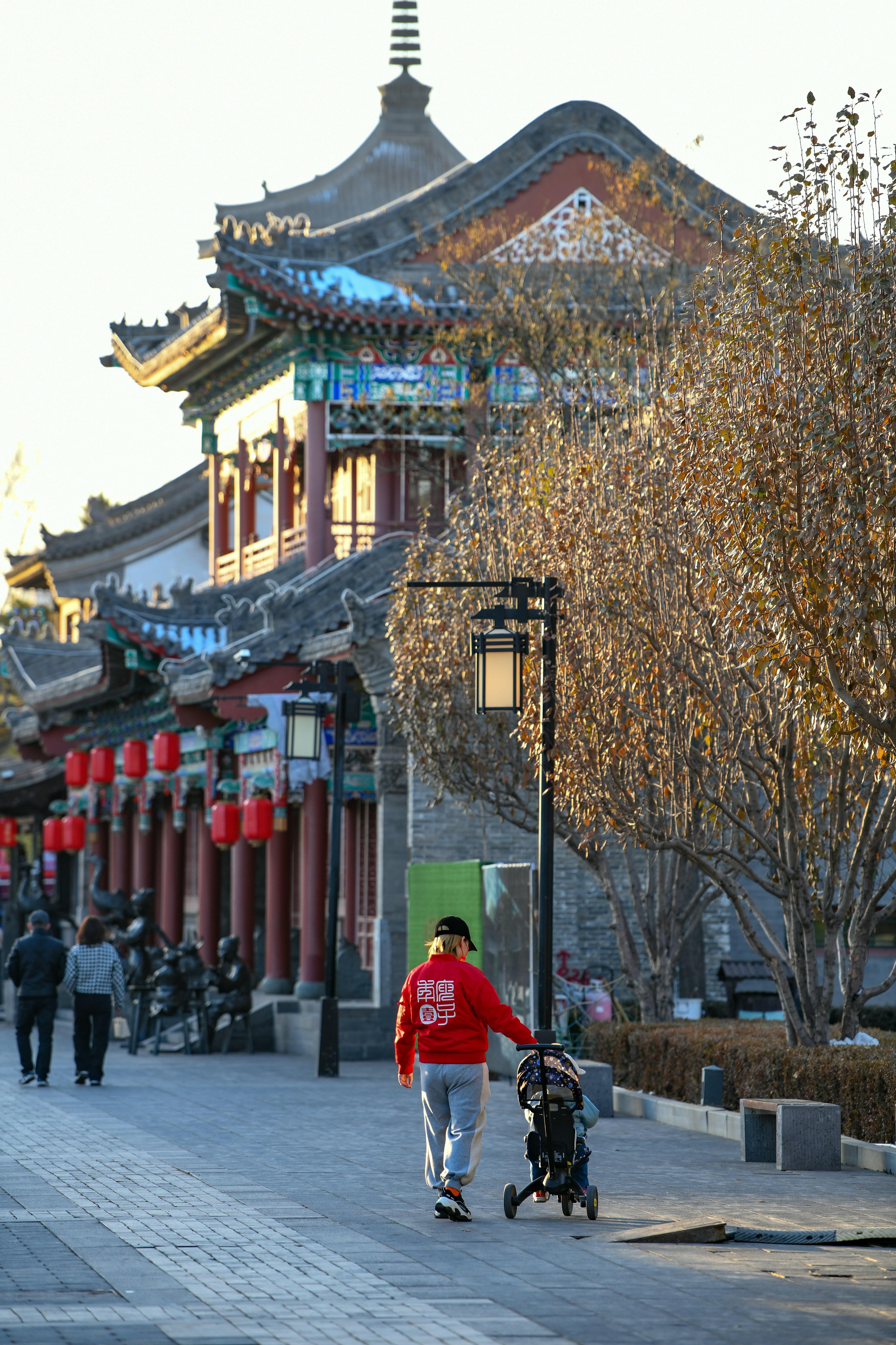 Red-Jacket Stroll Through a Lantern-Lined Old Town Arcade