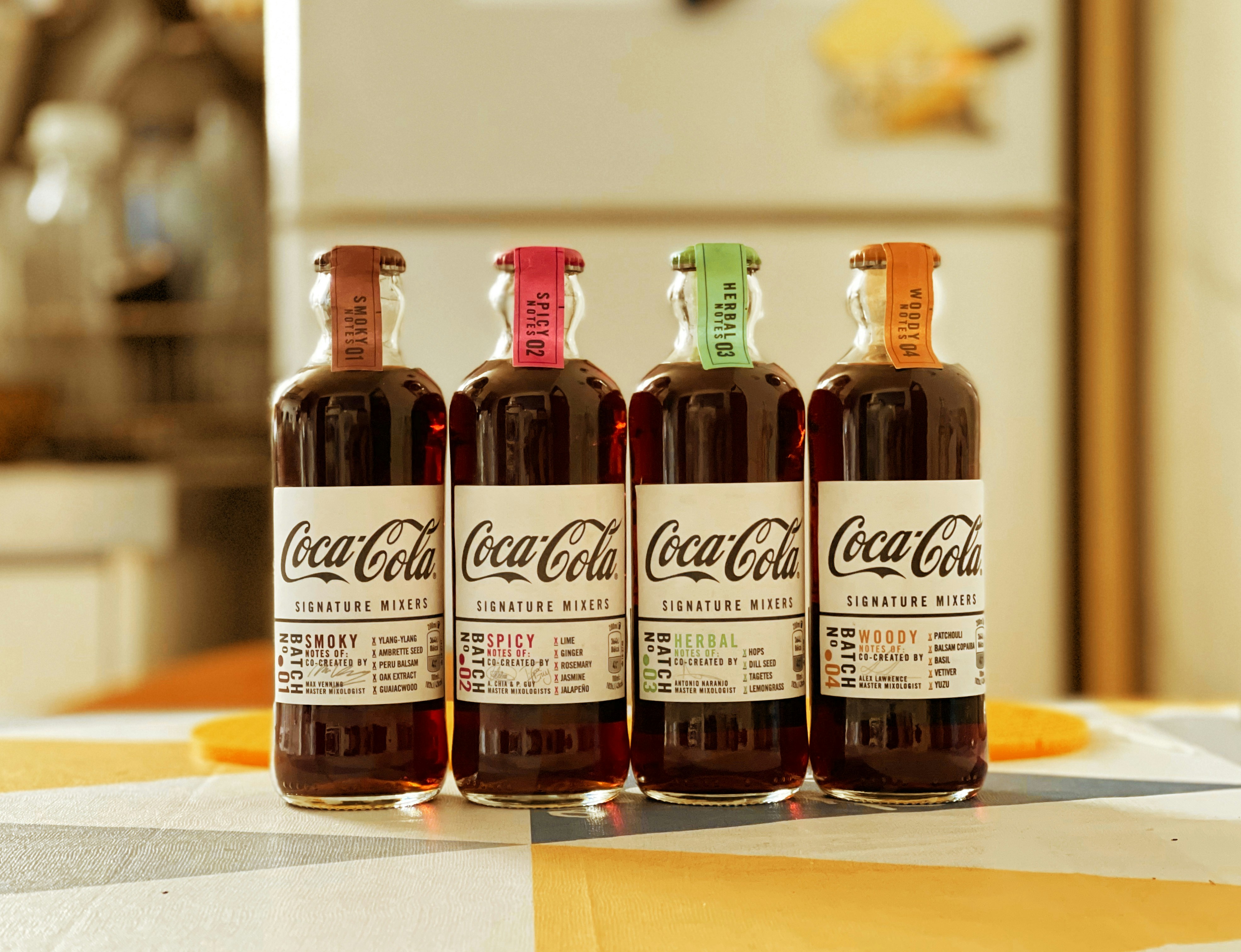 Four bottles of coca cola sitting on a table photo – Free Liquor Image ...