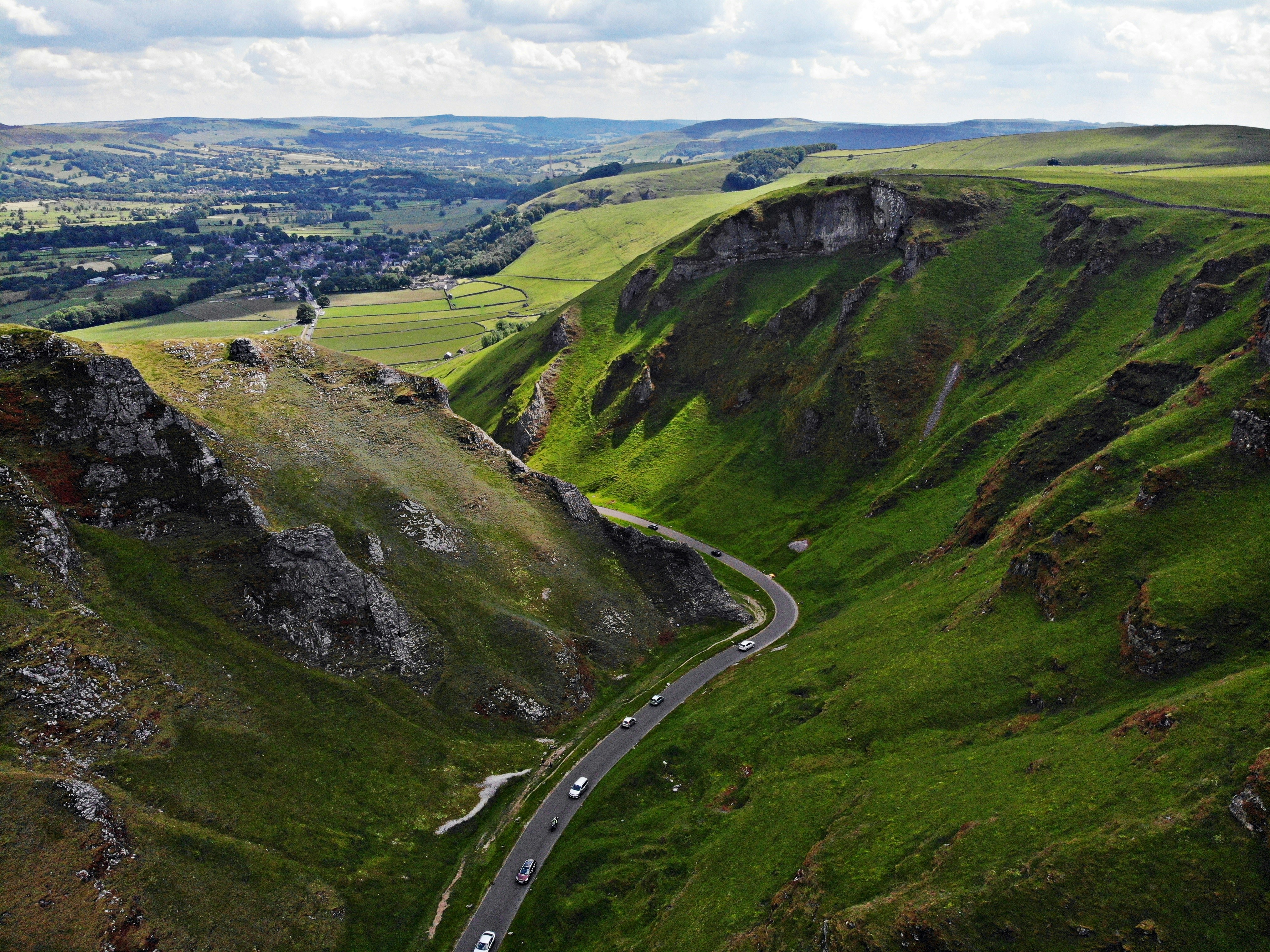 Ribbon Road Winding Through Emerald Valleys and Craggy Cliffs